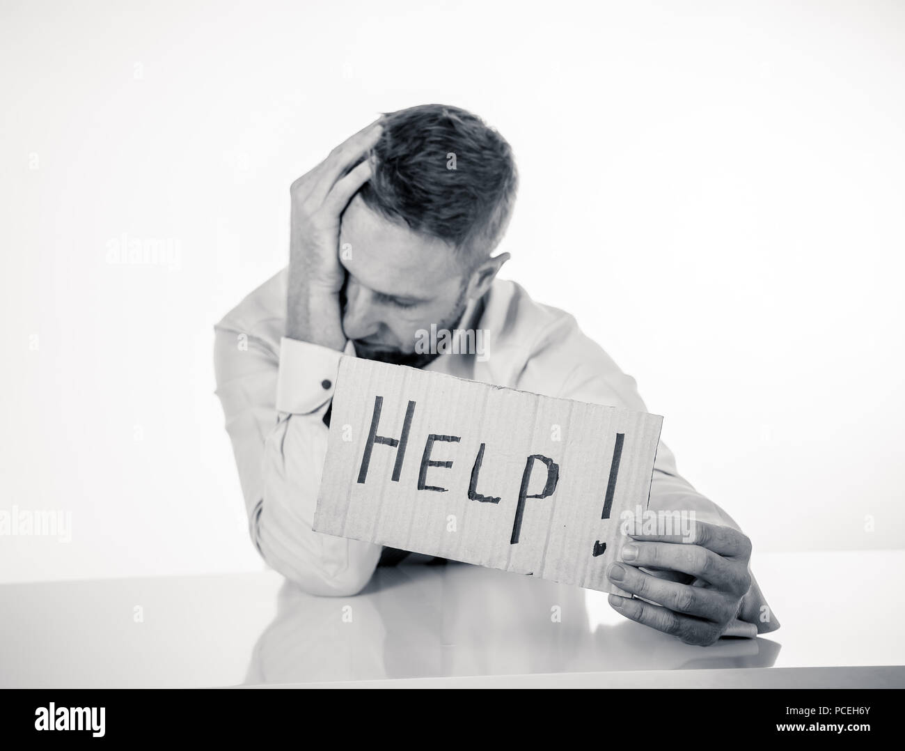 Businessman holding help sign message Stock Photo - Alamy