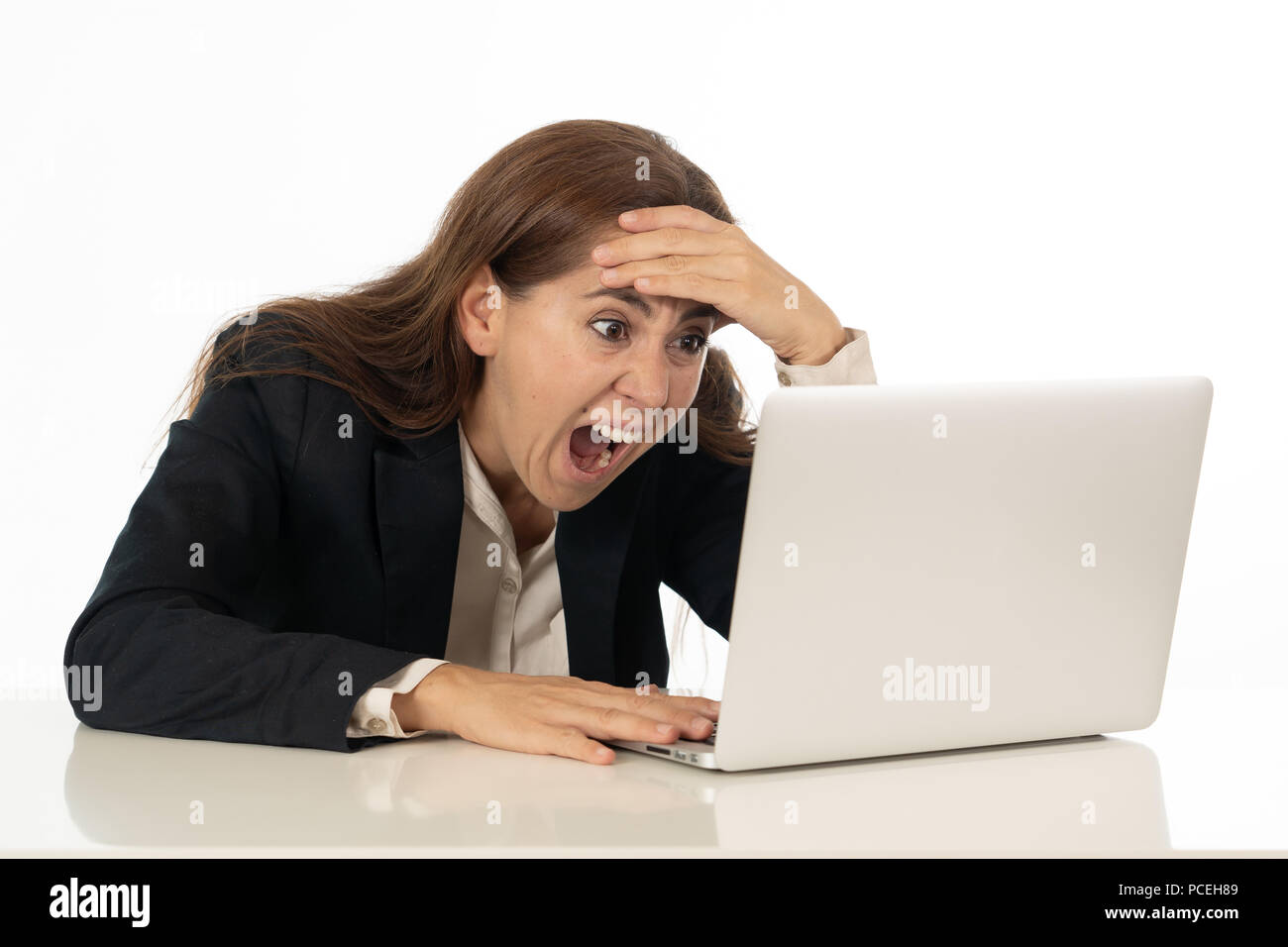 Business woman desperate with computer Stock Photo - Alamy