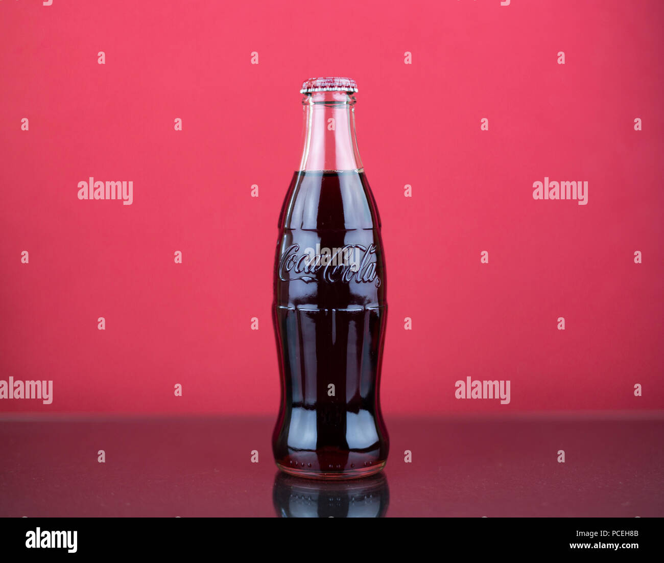 coca-cola contour bottle with embossed logo from United Kingdom on red ...