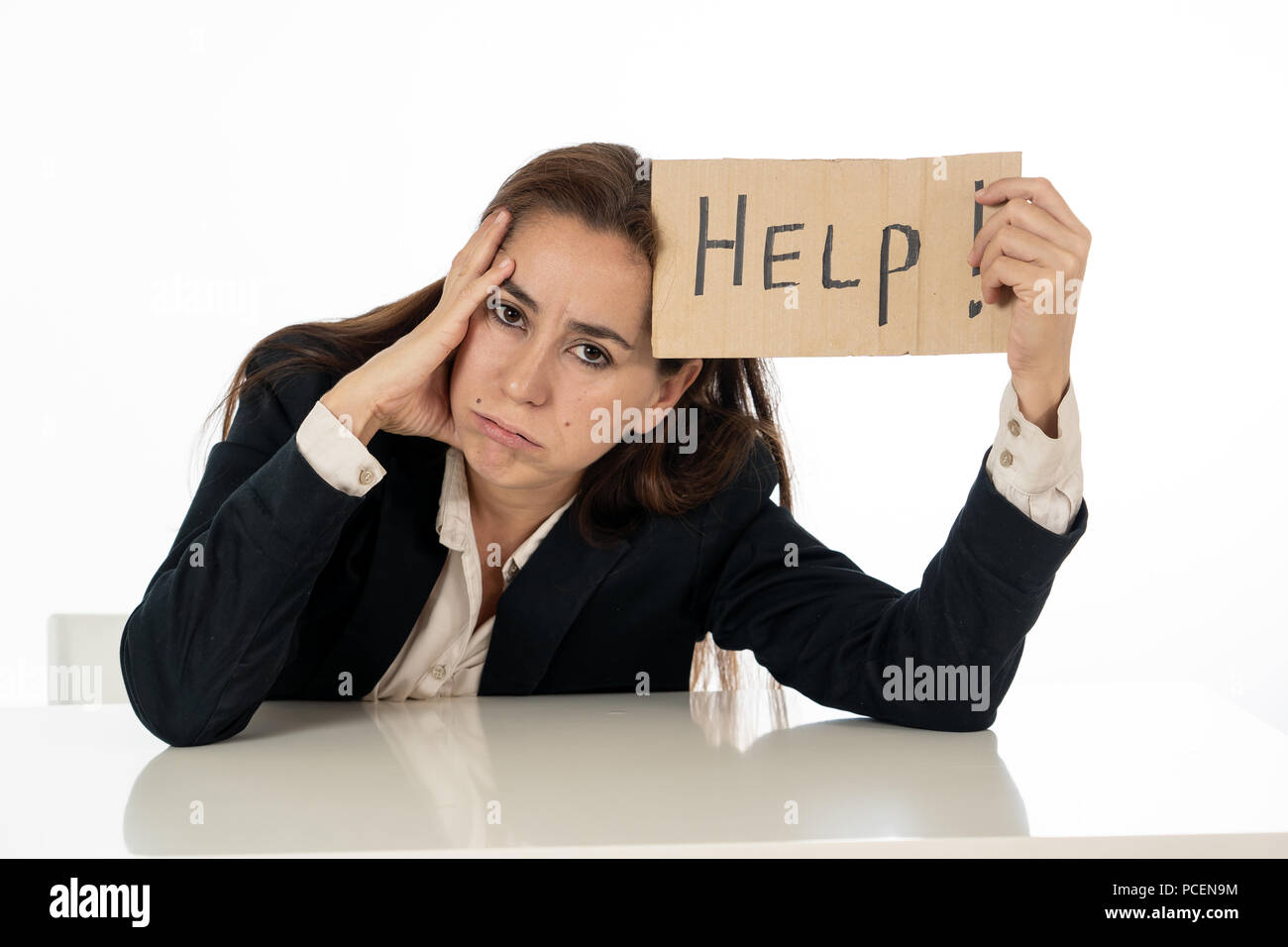 Sad businesswoman holding a help sign Stock Photo - Alamy