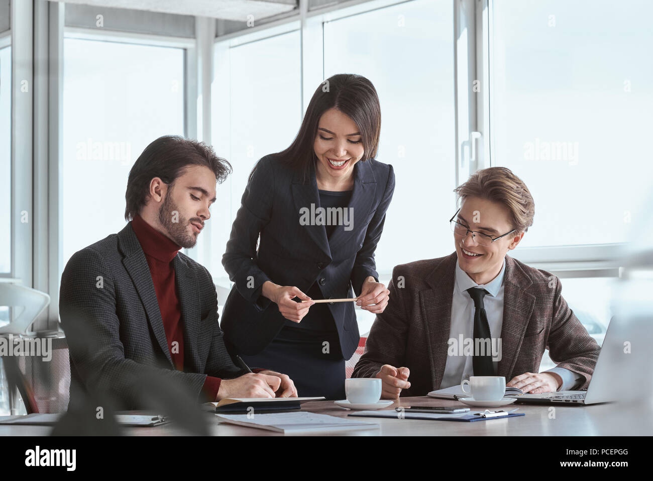 Businesspeople at office working together signing agreement Stock Photo ...
