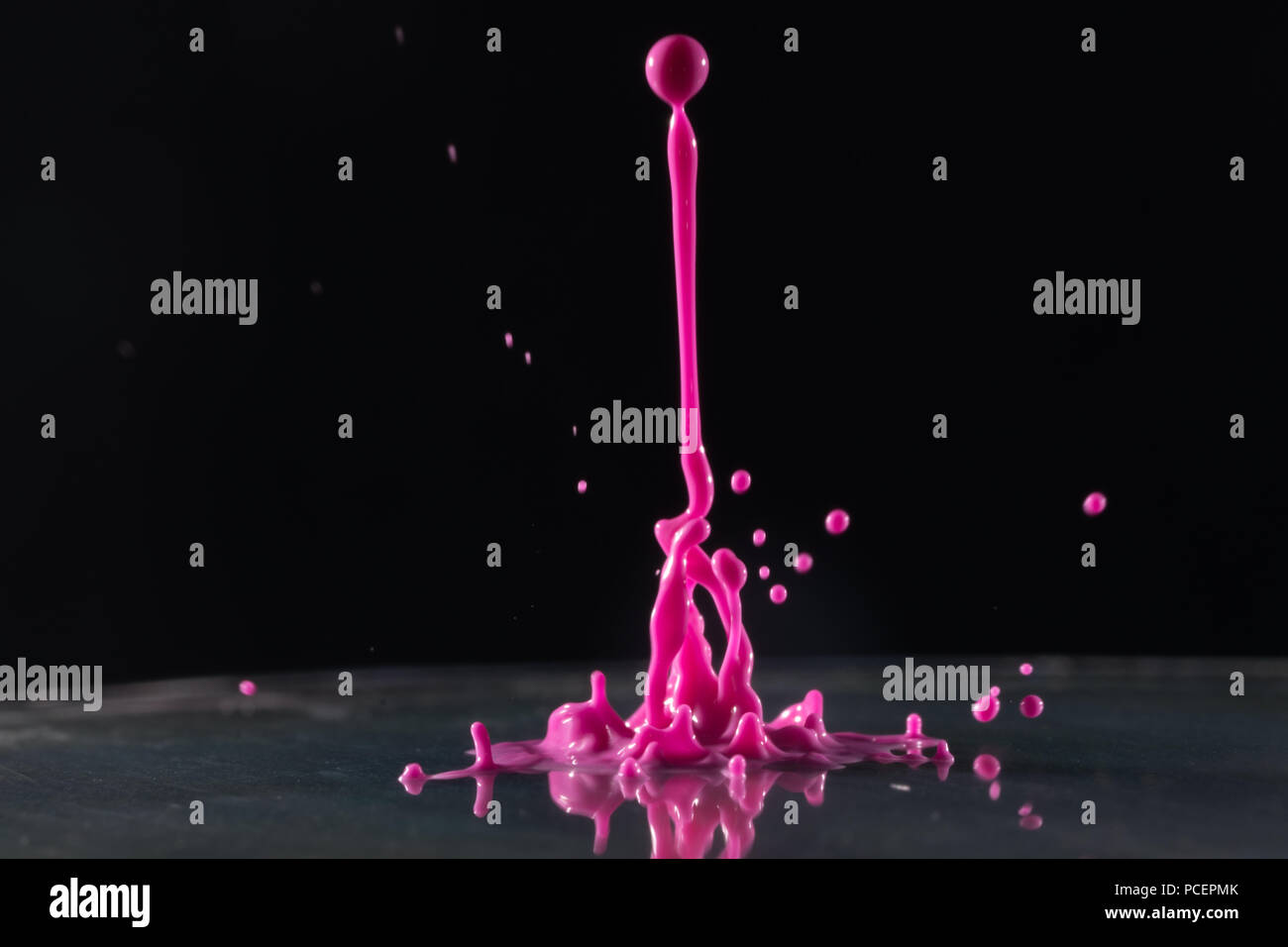 Magenta, pink paint, ink splash on black background Stock Photo - Alamy