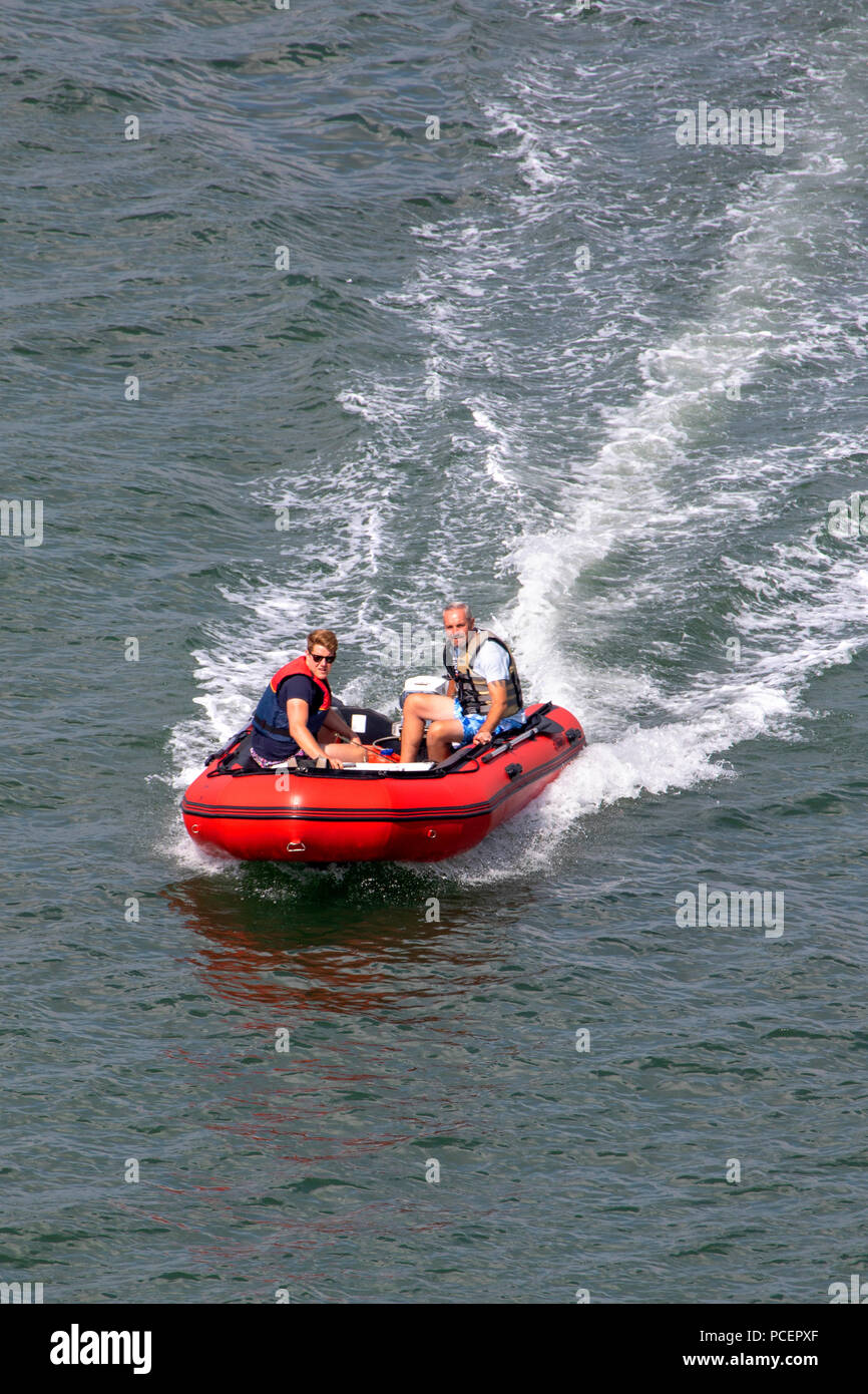 2 men riding a C sport inflatable rib dinghy boat on the Solent in ...