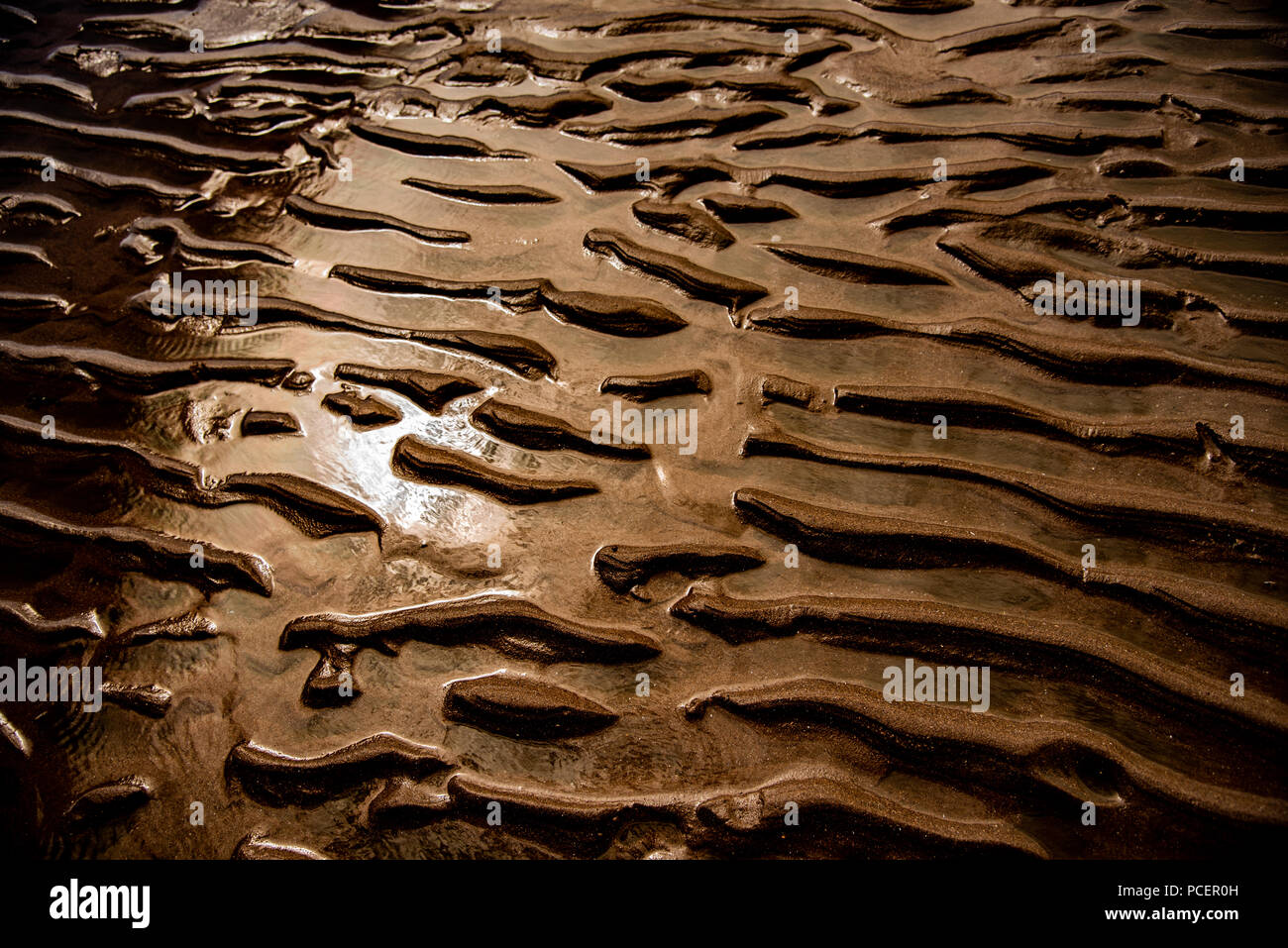 Interesting pattern created by the tide on a beach, creating an ...