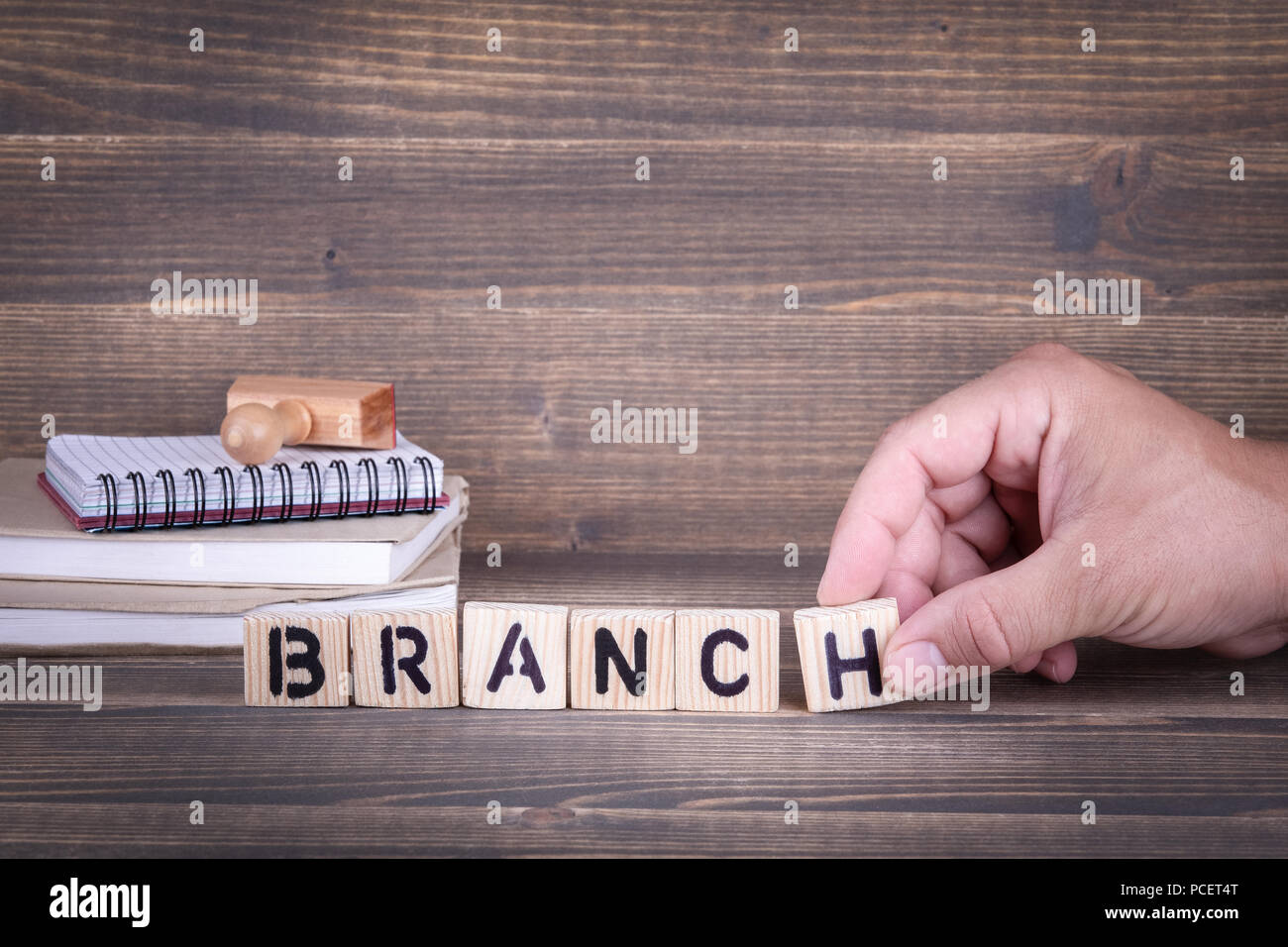 branch. wooden letters on the office desk Stock Photo - Alamy