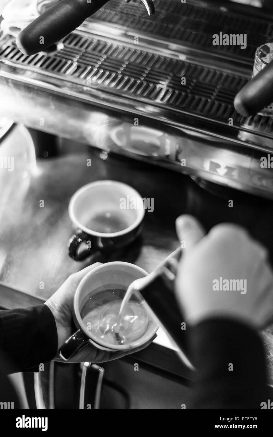 making espresso coffee BW black and white close up detail with modern ...