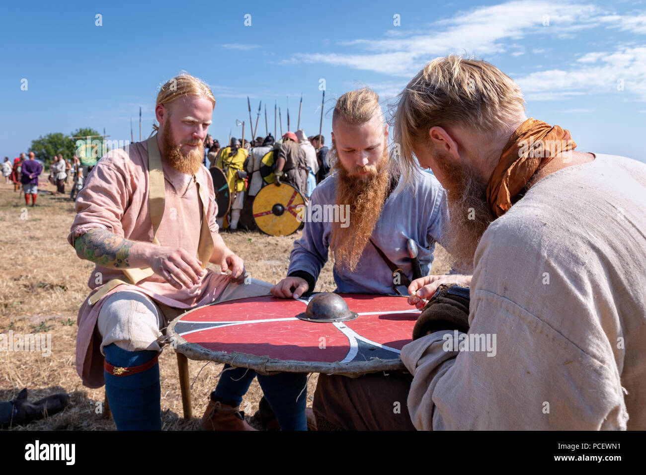 Three men playing dice before A Battle reenactment at the worlds ...