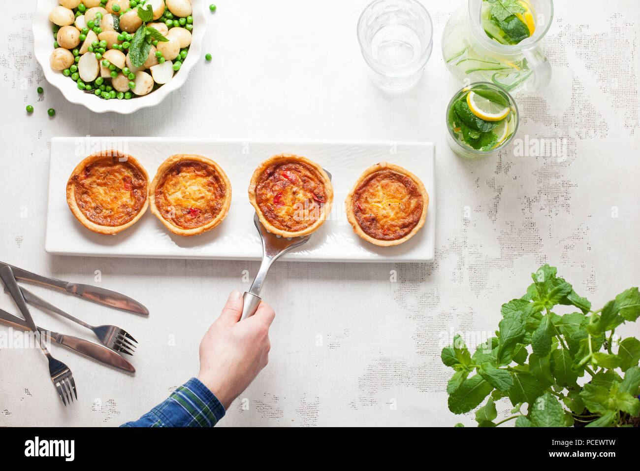 Individual mini quiches on a white rectangular plate Stock Photo - Alamy