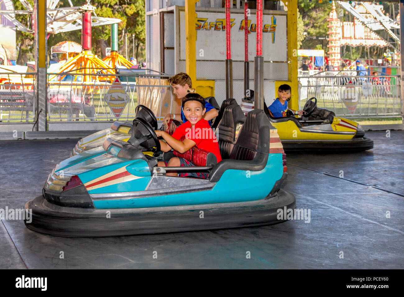 Boys enjoying ride at amusement park hi-res stock photography and ...