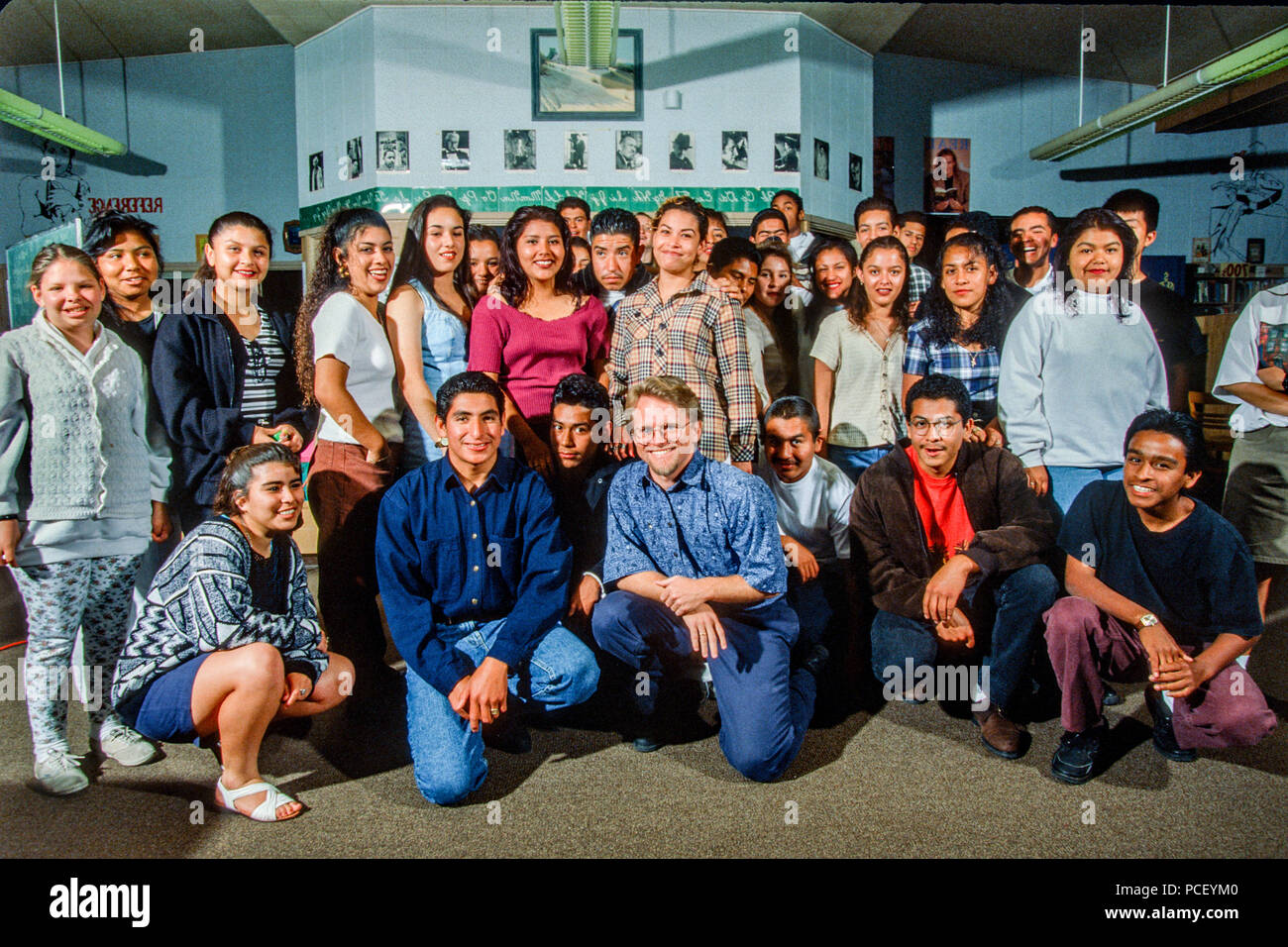 A community college English professor and his Hispanic students pose ...