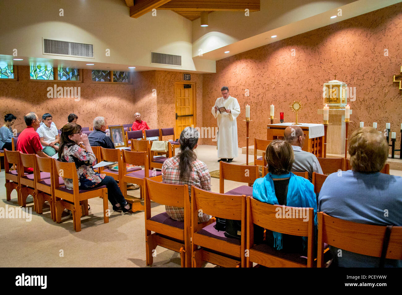 A robed deacon conducts a Divine Mercy With Benediction service to a ...