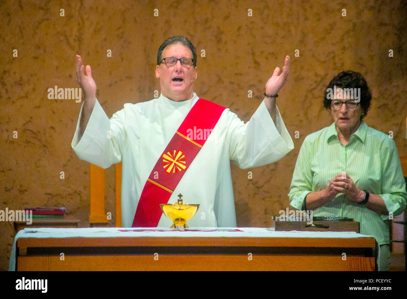 A robed and red-shashed deacon conducts a Liturgy of the Word with Rite ...