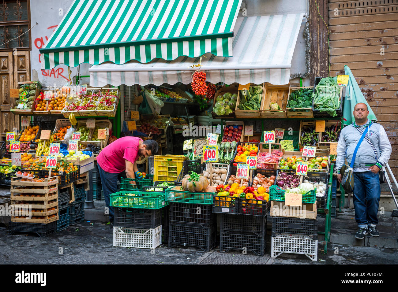 NAPLES, ITALY - OCTOBER 16, 2017: A vendor tends his merchandise at a ...