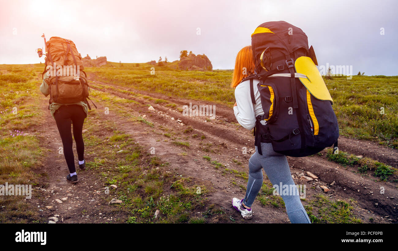 Travel Lifestyle and survival concept rear view. Hiking women with ...