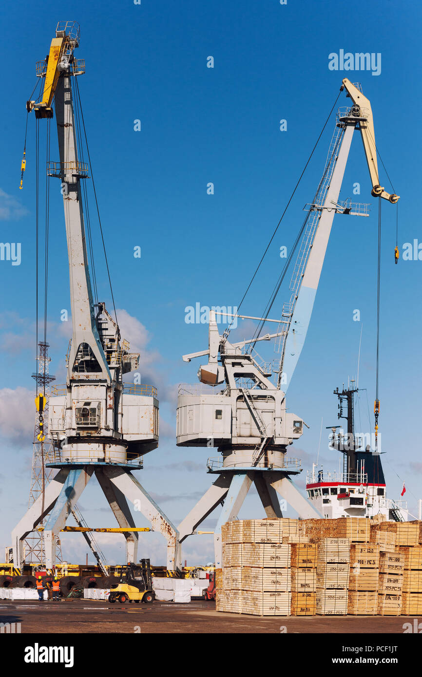 Wooden blocks on the loading at the port with cranes and loaders Stock ...