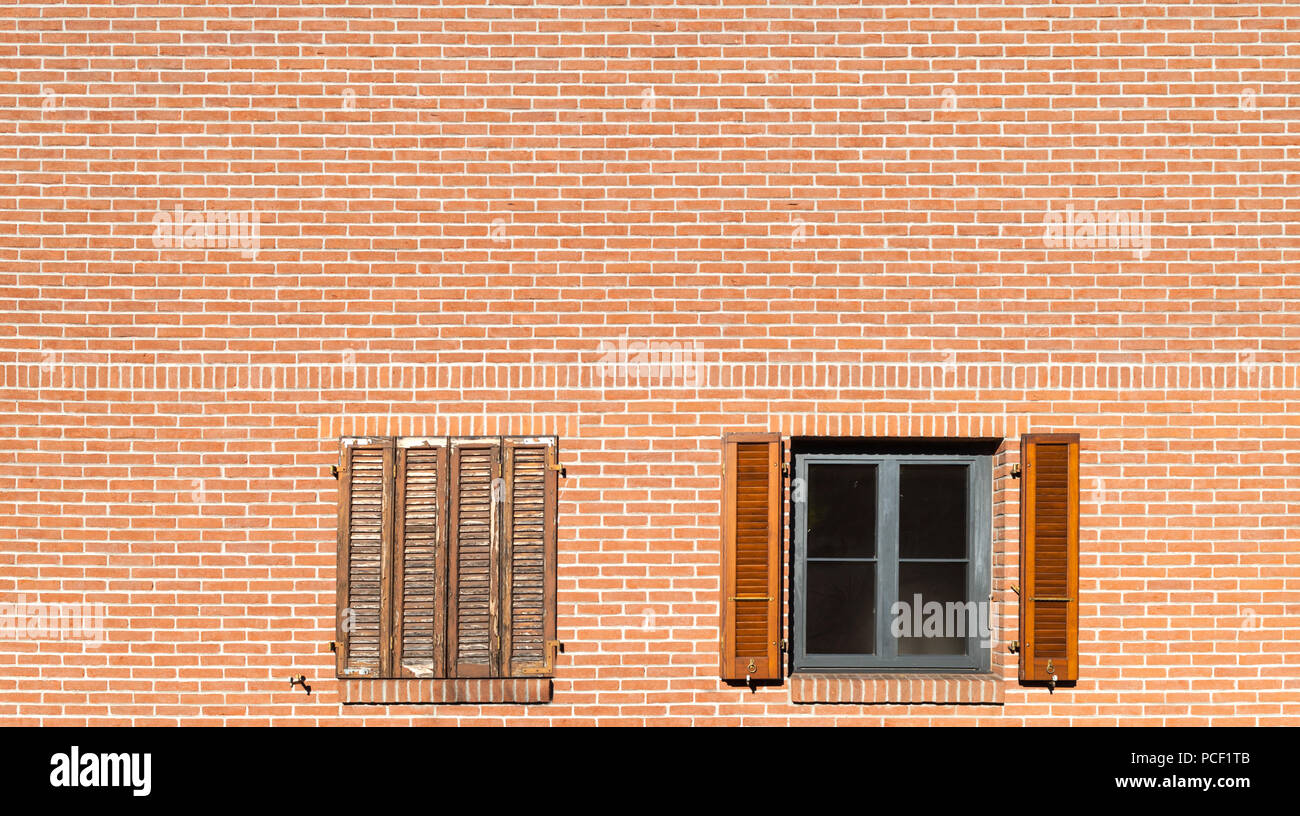 facade of a building with two windows, brick wall Stock Photo - Alamy