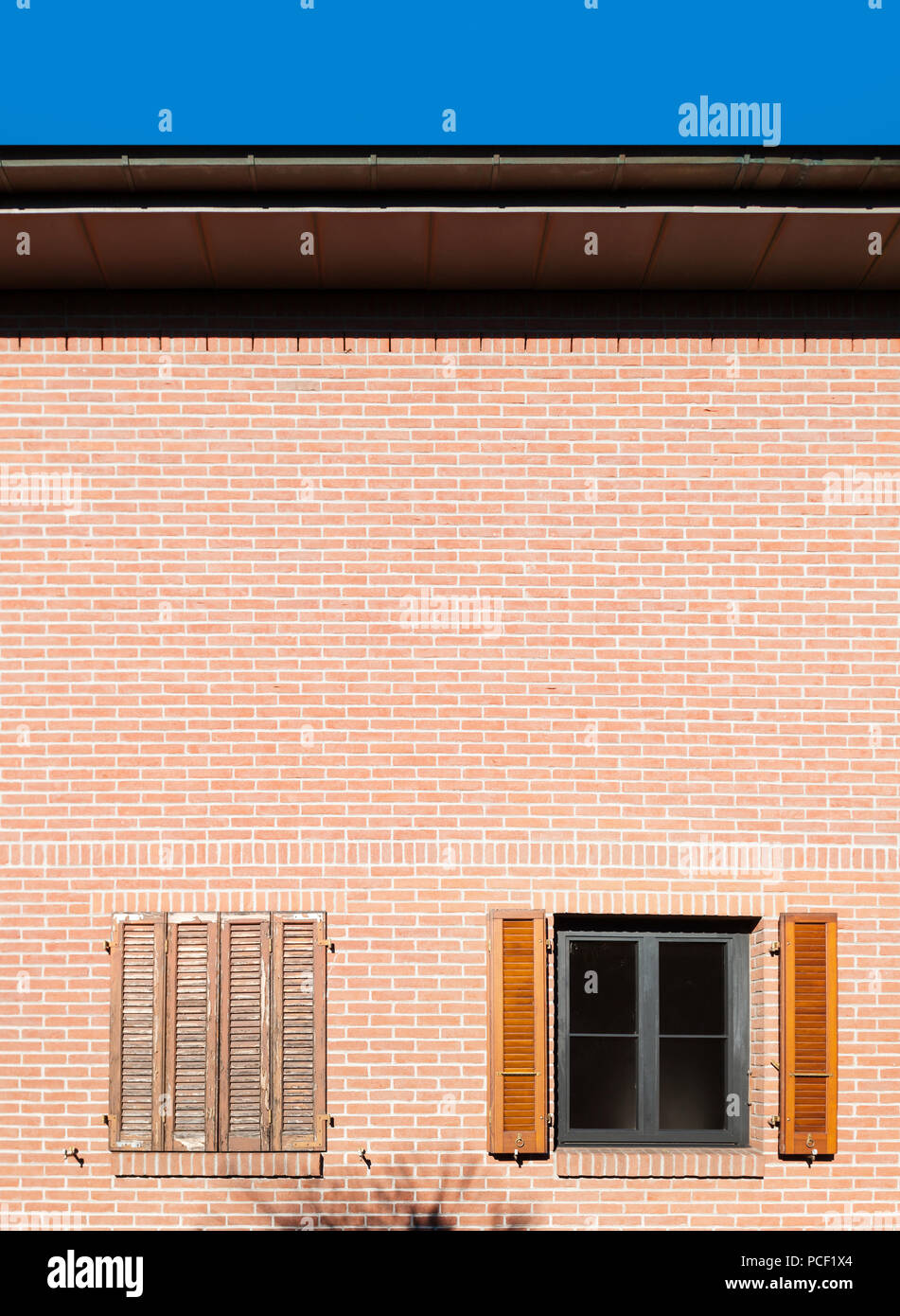 facade of a building with two windows, brick wall Stock Photo - Alamy