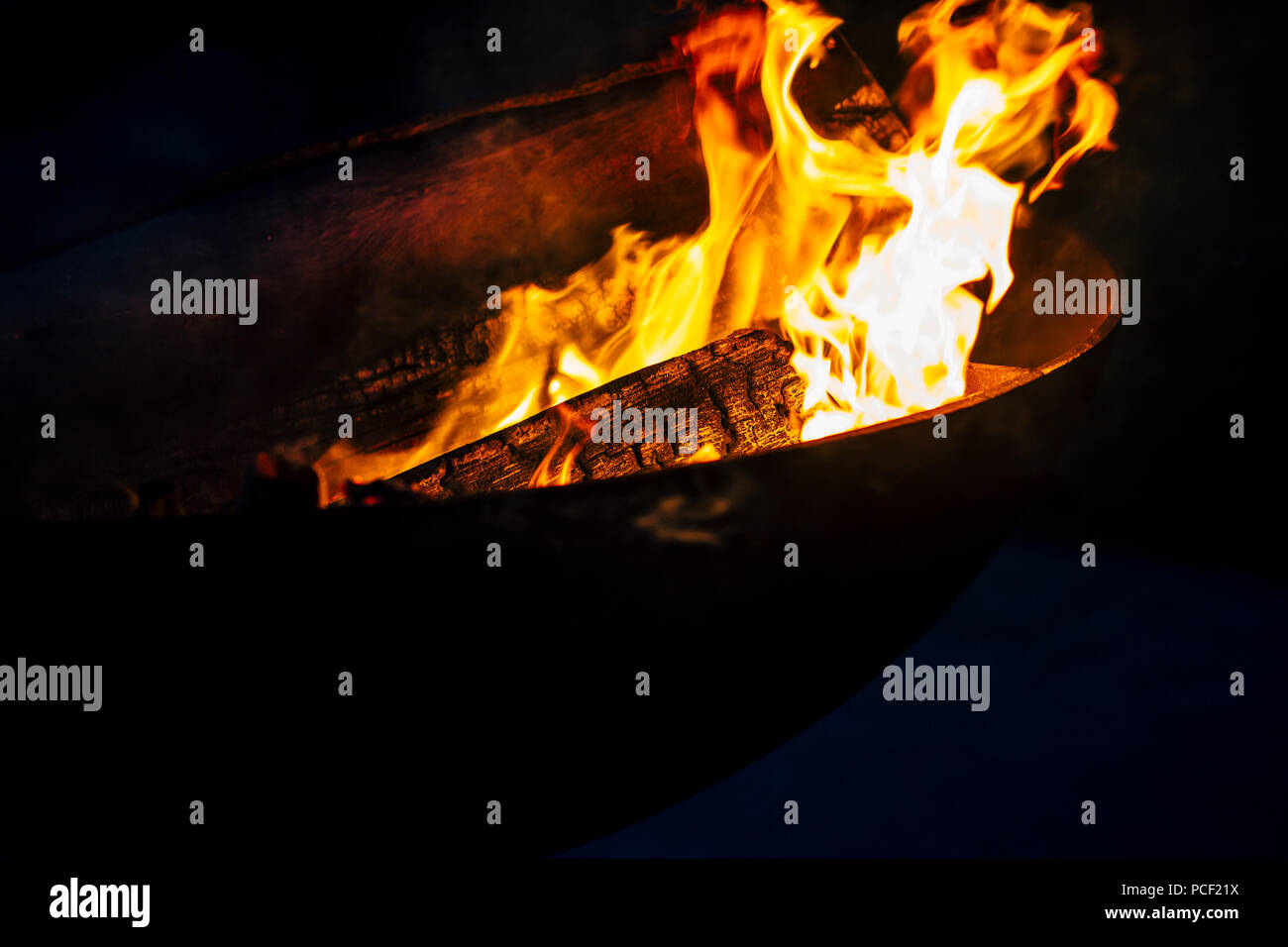 Night scene of fire sparks and flame burning with beautiful red flame ...