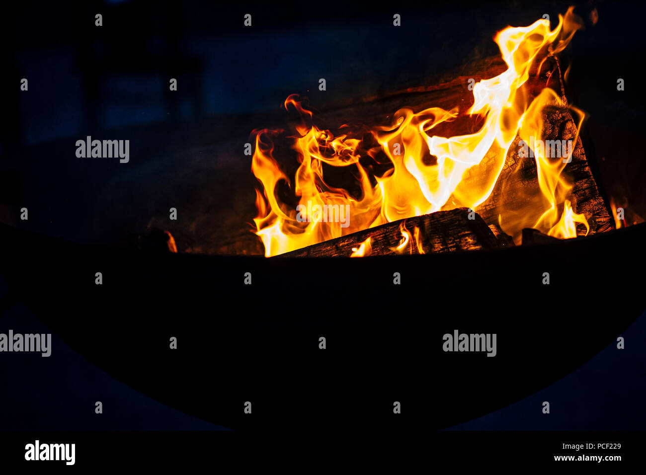 Night scene of fire sparks and flame burning with beautiful red flame ...
