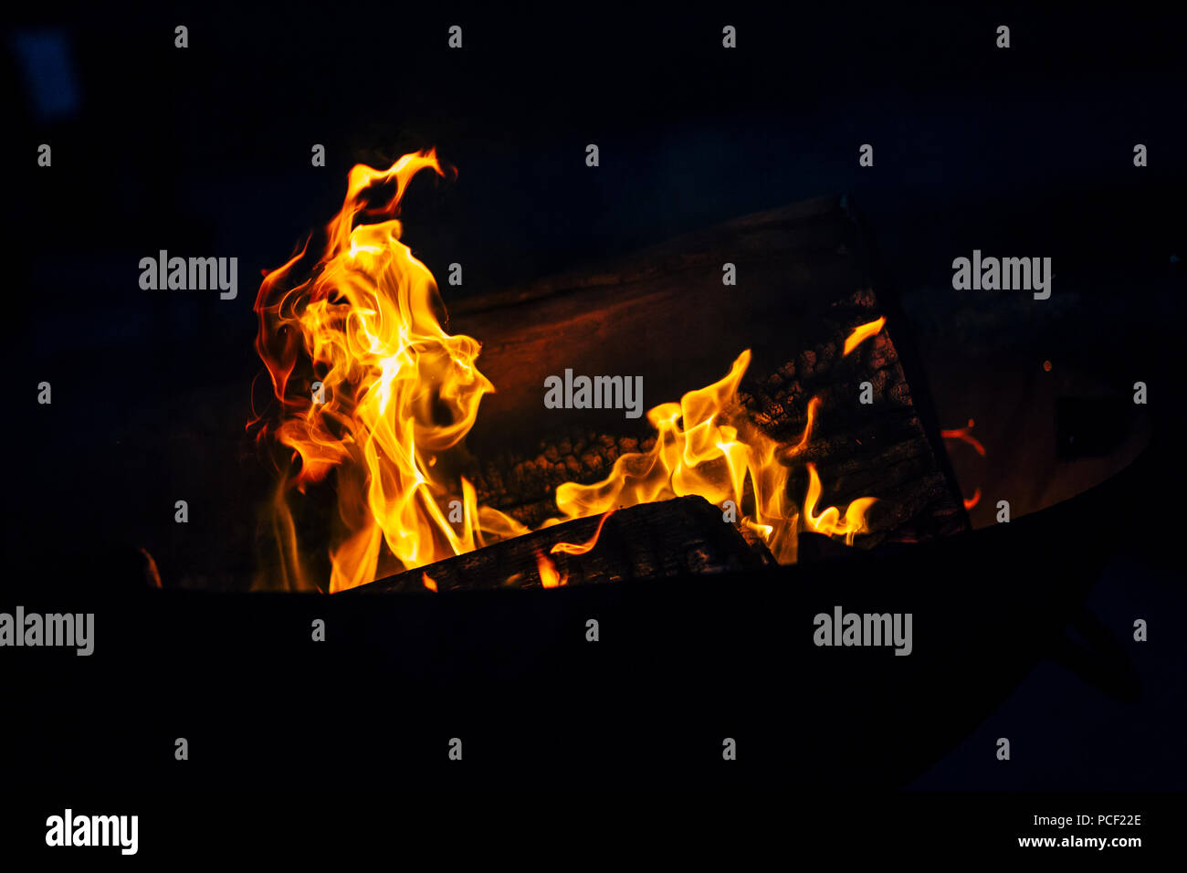 Night scene of fire sparks and flame burning with beautiful red flame ...