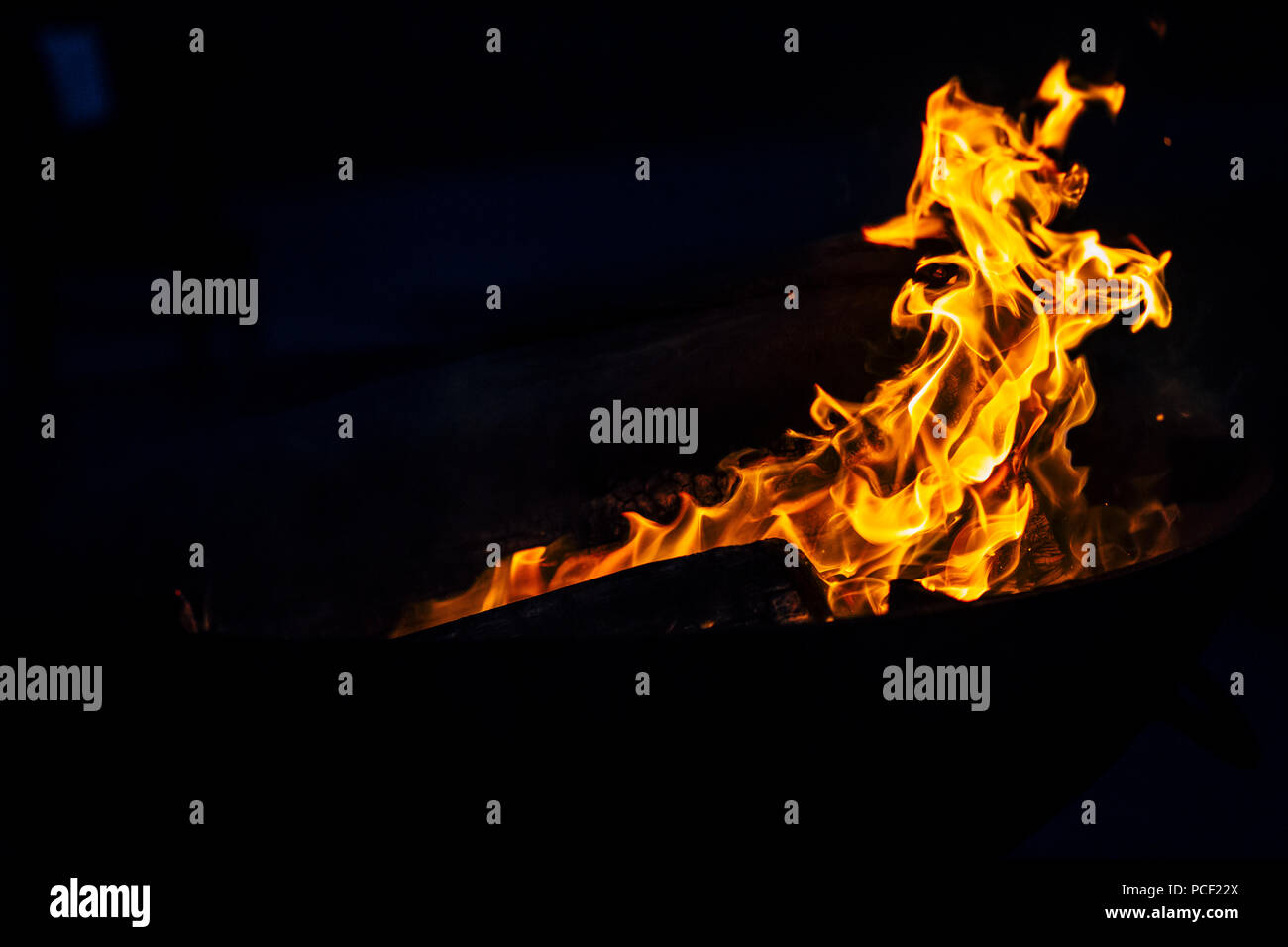 Night scene of fire sparks and flame burning with beautiful red flame ...