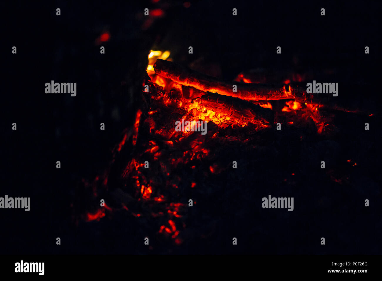 Night scene of fire sparks and flame burning with beautiful red flame ...