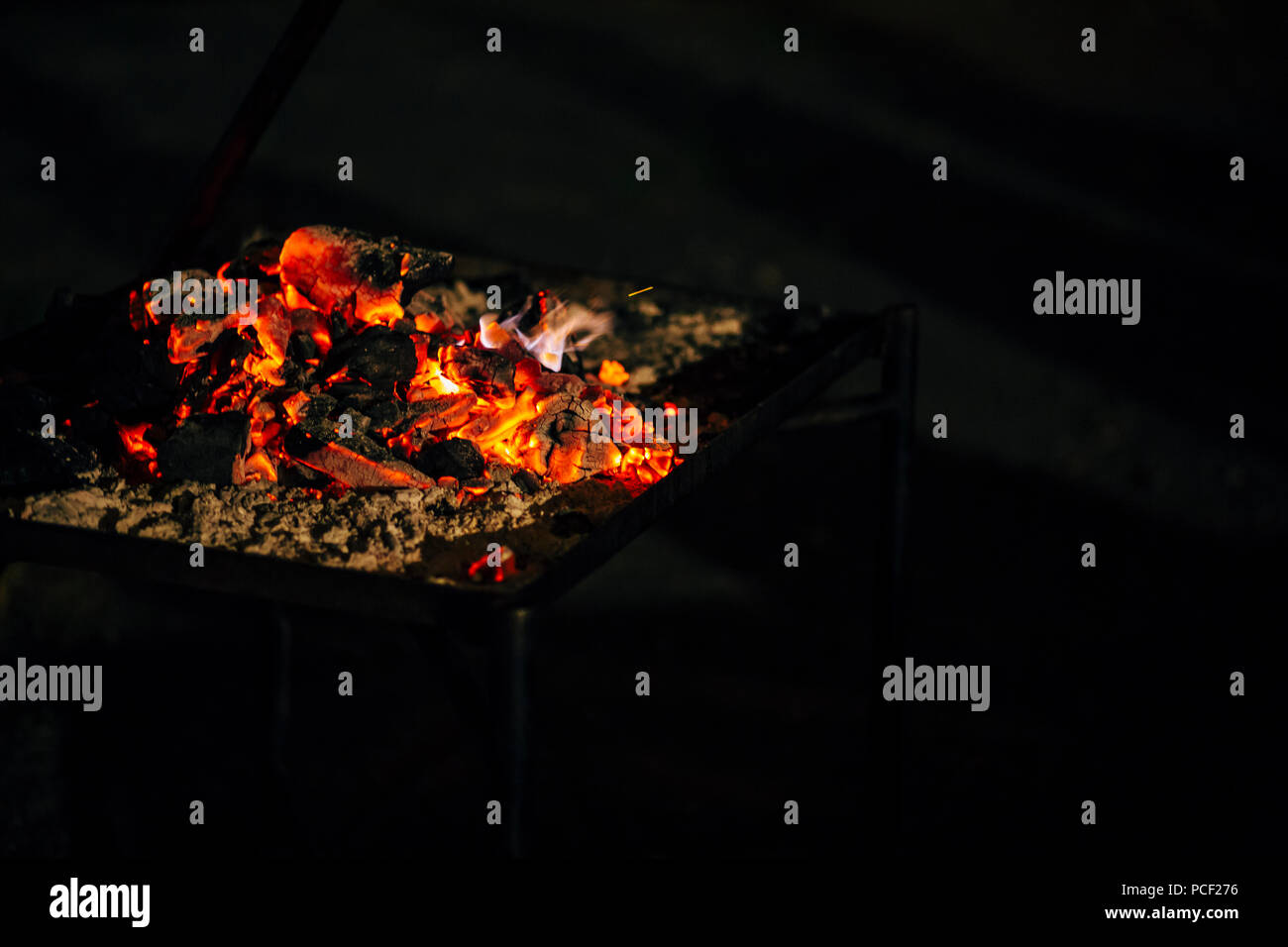 Night scene of fire sparks and flame burning with beautiful red flame ...