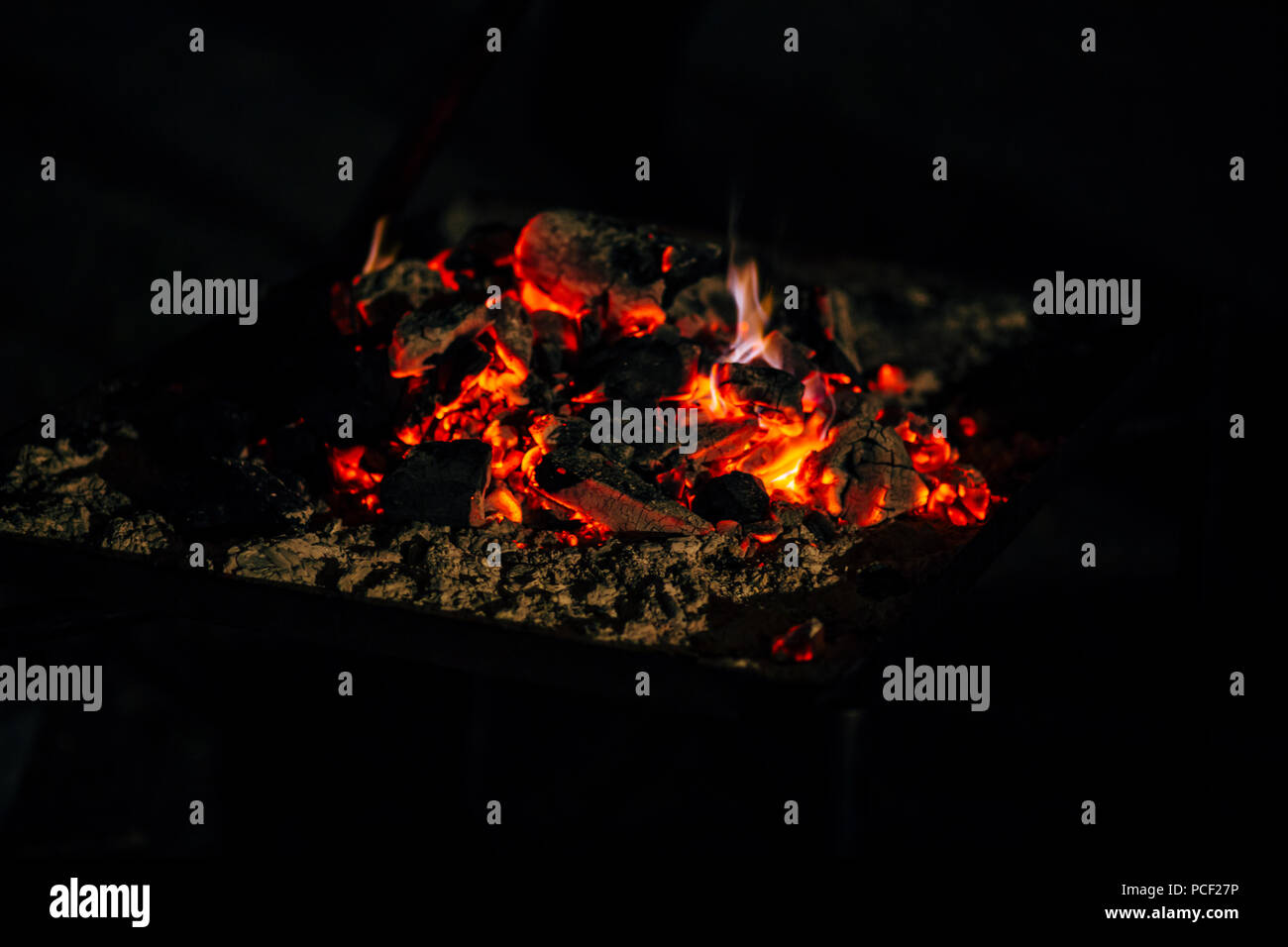 Night scene of fire sparks and flame burning with beautiful red flame ...