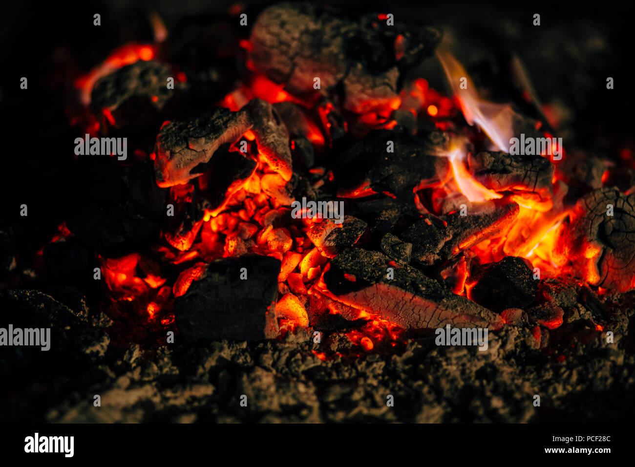Night scene of fire sparks and flame burning with beautiful red flame ...