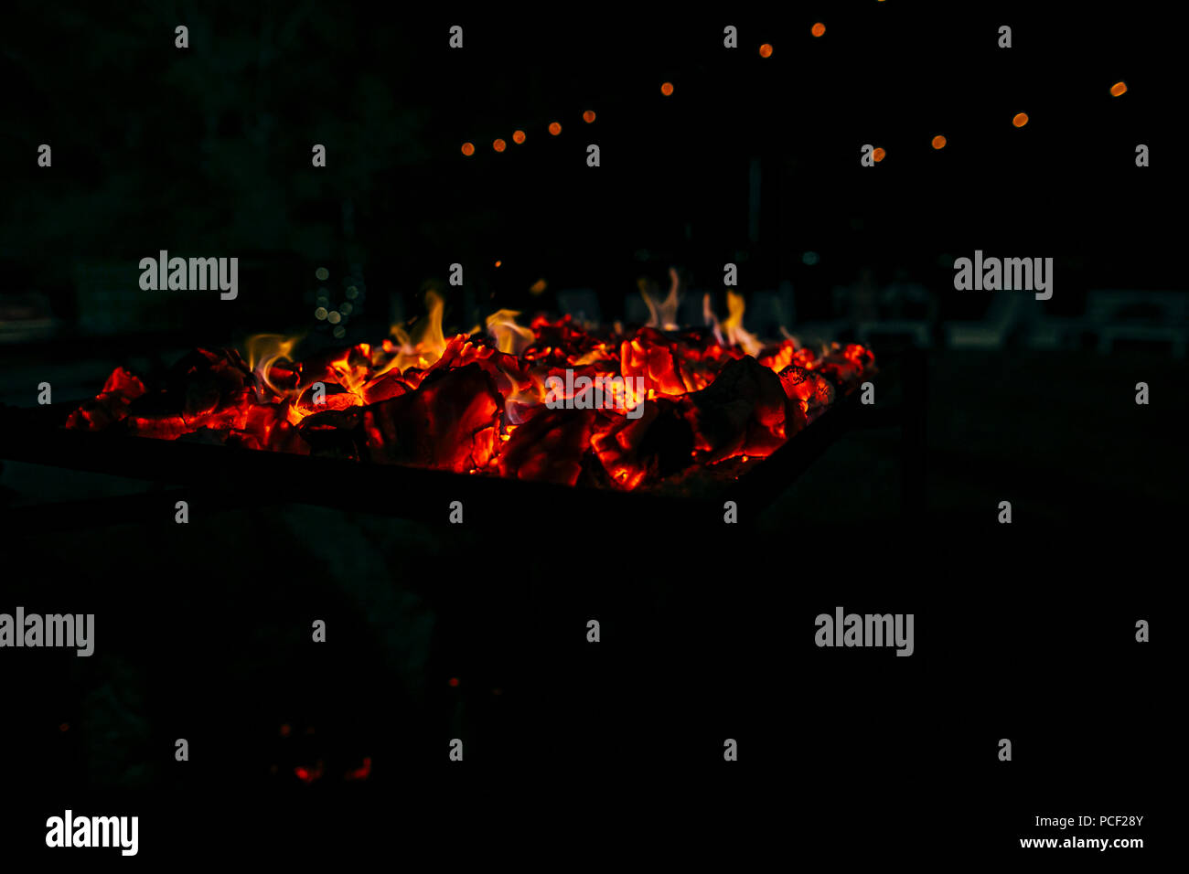 Night scene of fire sparks and flame burning with beautiful red flame ...