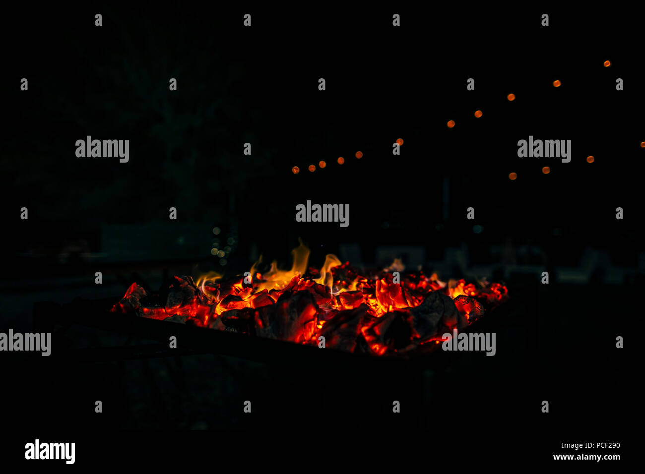 Night scene of fire sparks and flame burning with beautiful red flame ...