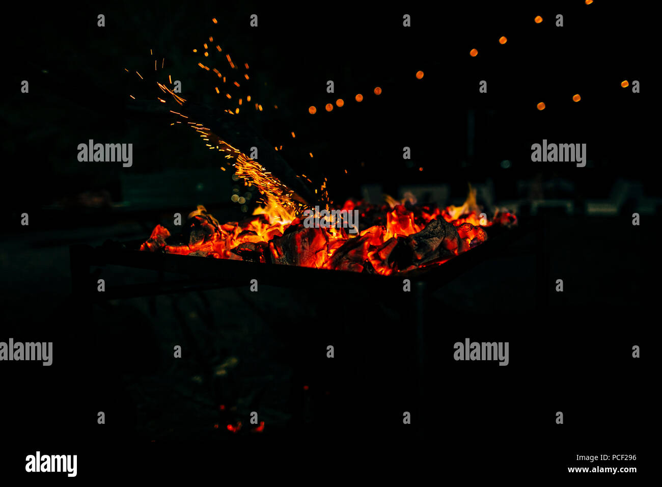 Night scene of fire sparks and flame burning with beautiful red flame ...