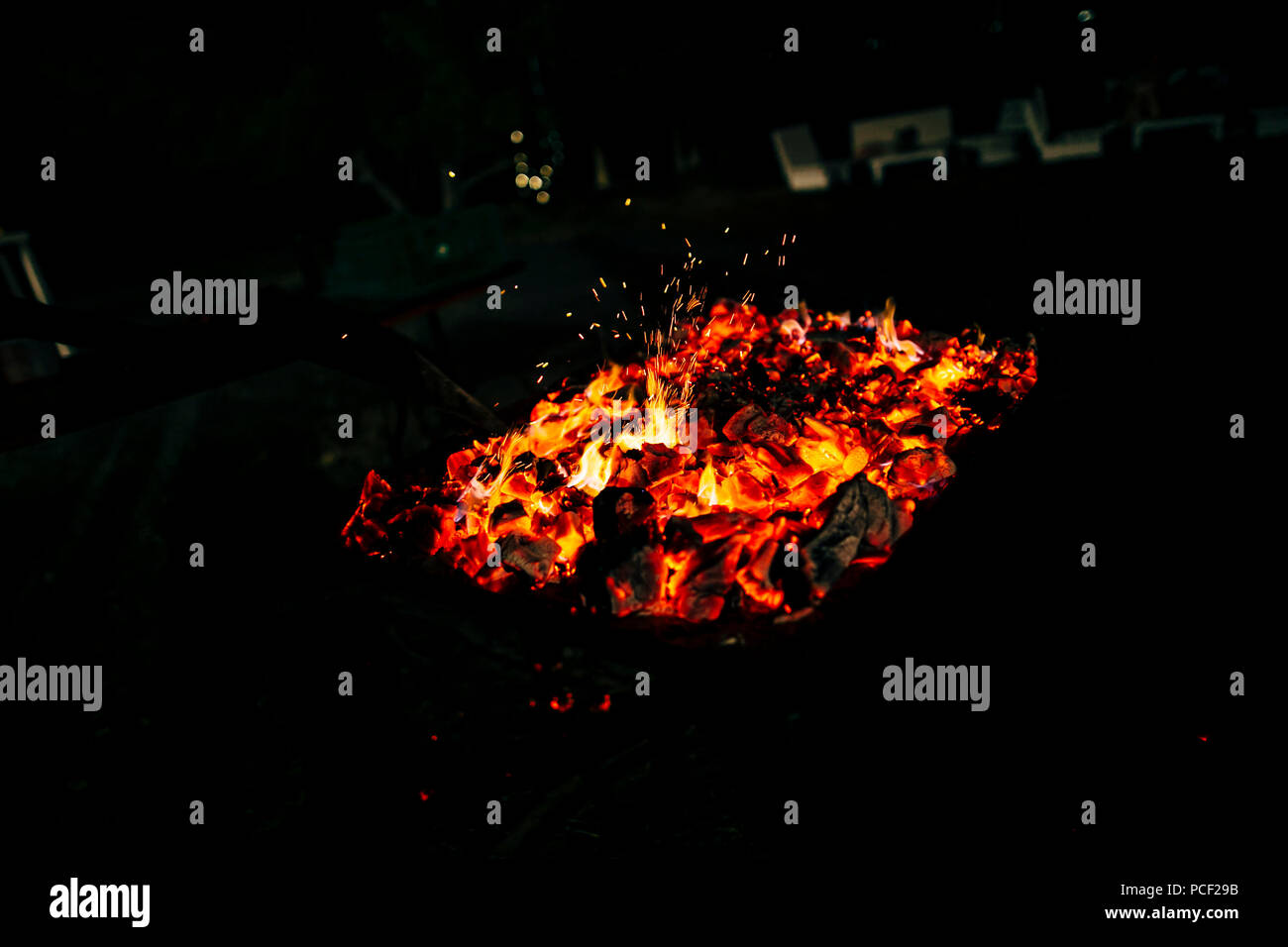 Night scene of fire sparks and flame burning with beautiful red flame ...
