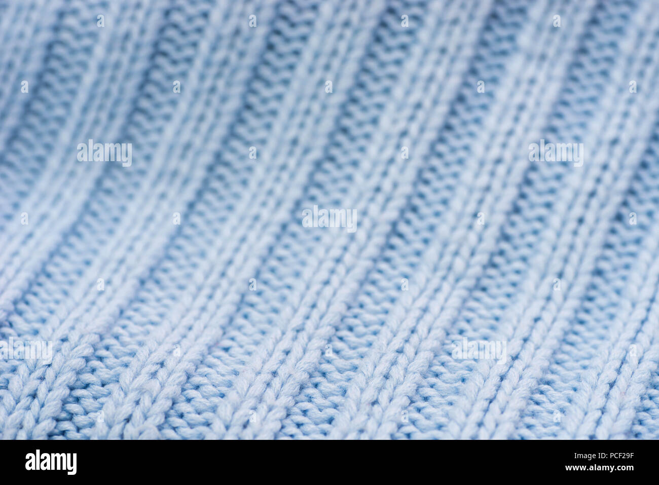 blue color waved knitwear texture background macro Stock Photo - Alamy