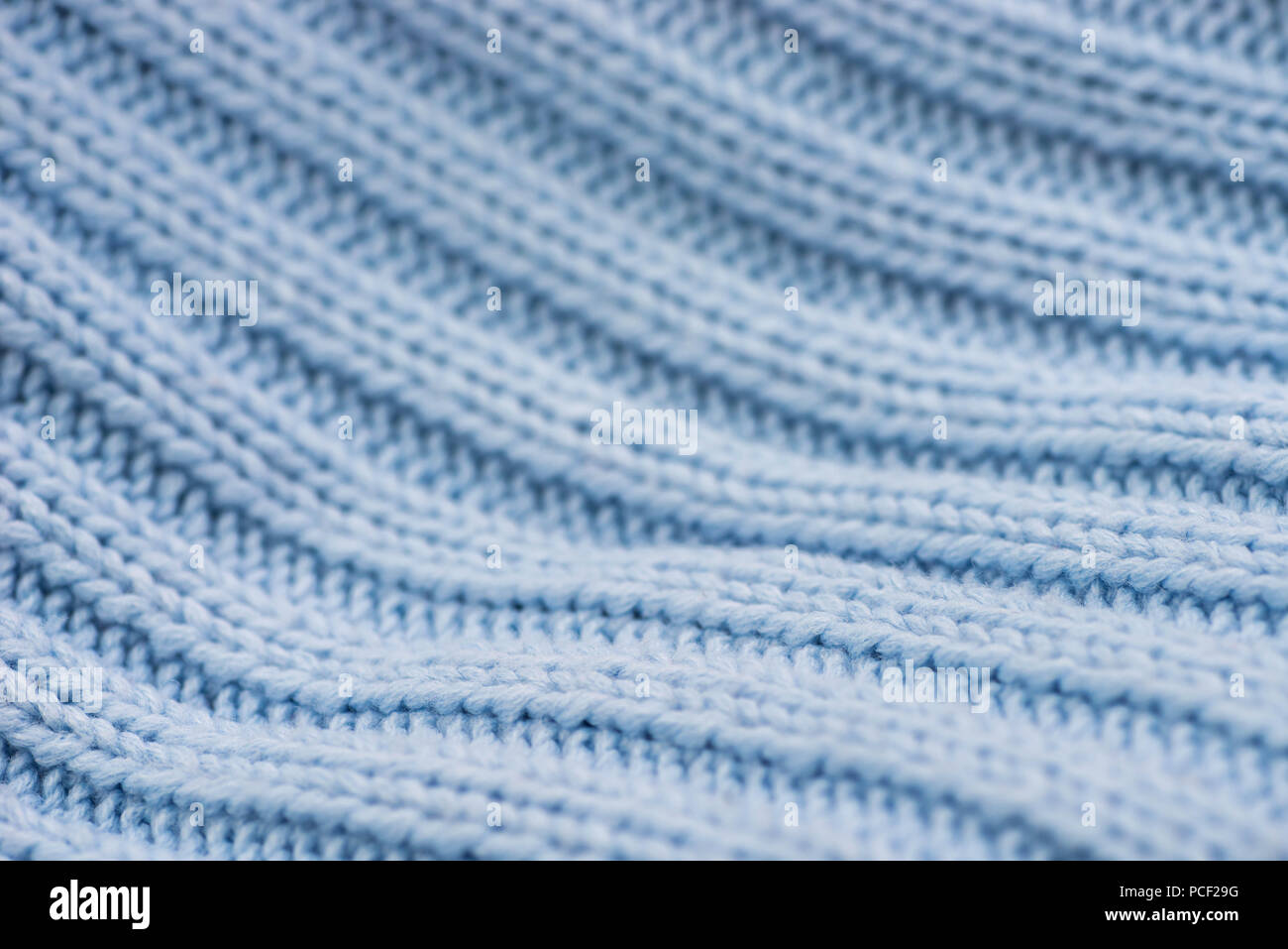 blue color waved knitwear texture background macro Stock Photo - Alamy