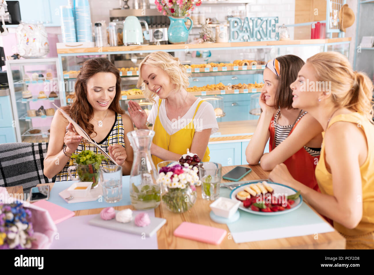 Four best friends having their traditional breakfast in bakery Stock ...