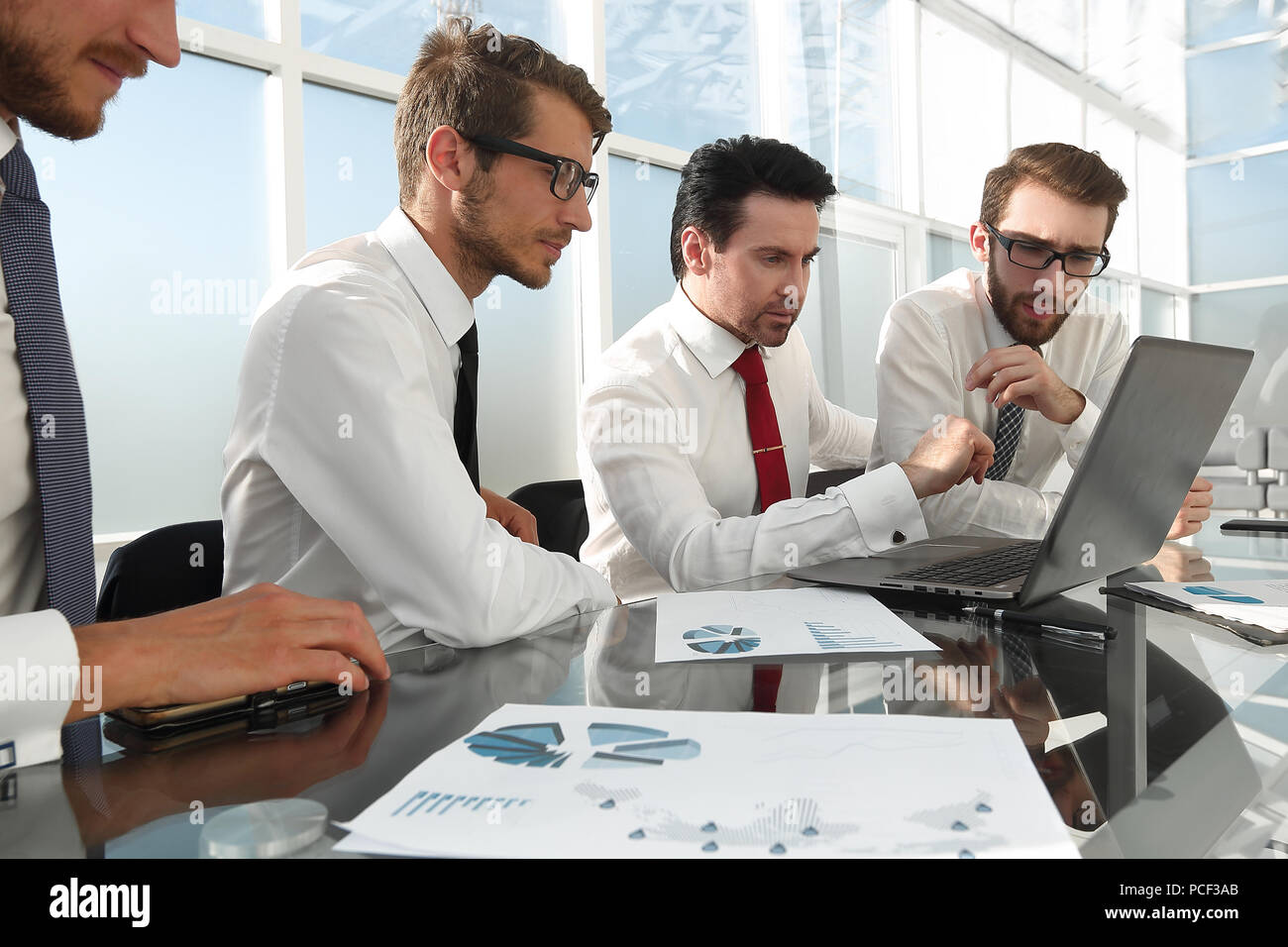 Full concentration at work. Group of young business people working and ...