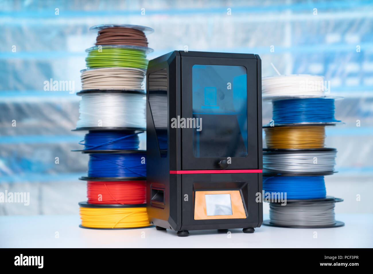ABS and PLA filament next to 3D Printer. Plastic coils Stock Photo - Alamy