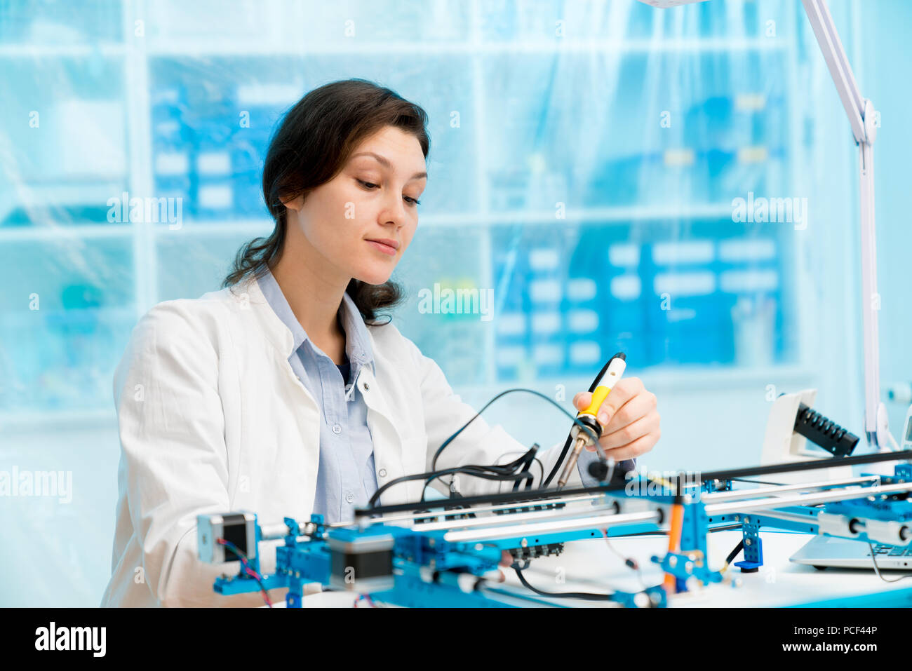 Student girl in electronics laboratory, experiment with microcontroller ...