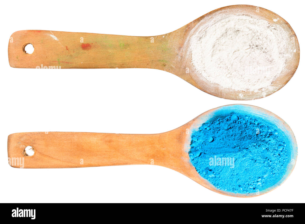 blue and white powder on wooden spoons with clipping path in isolated ...