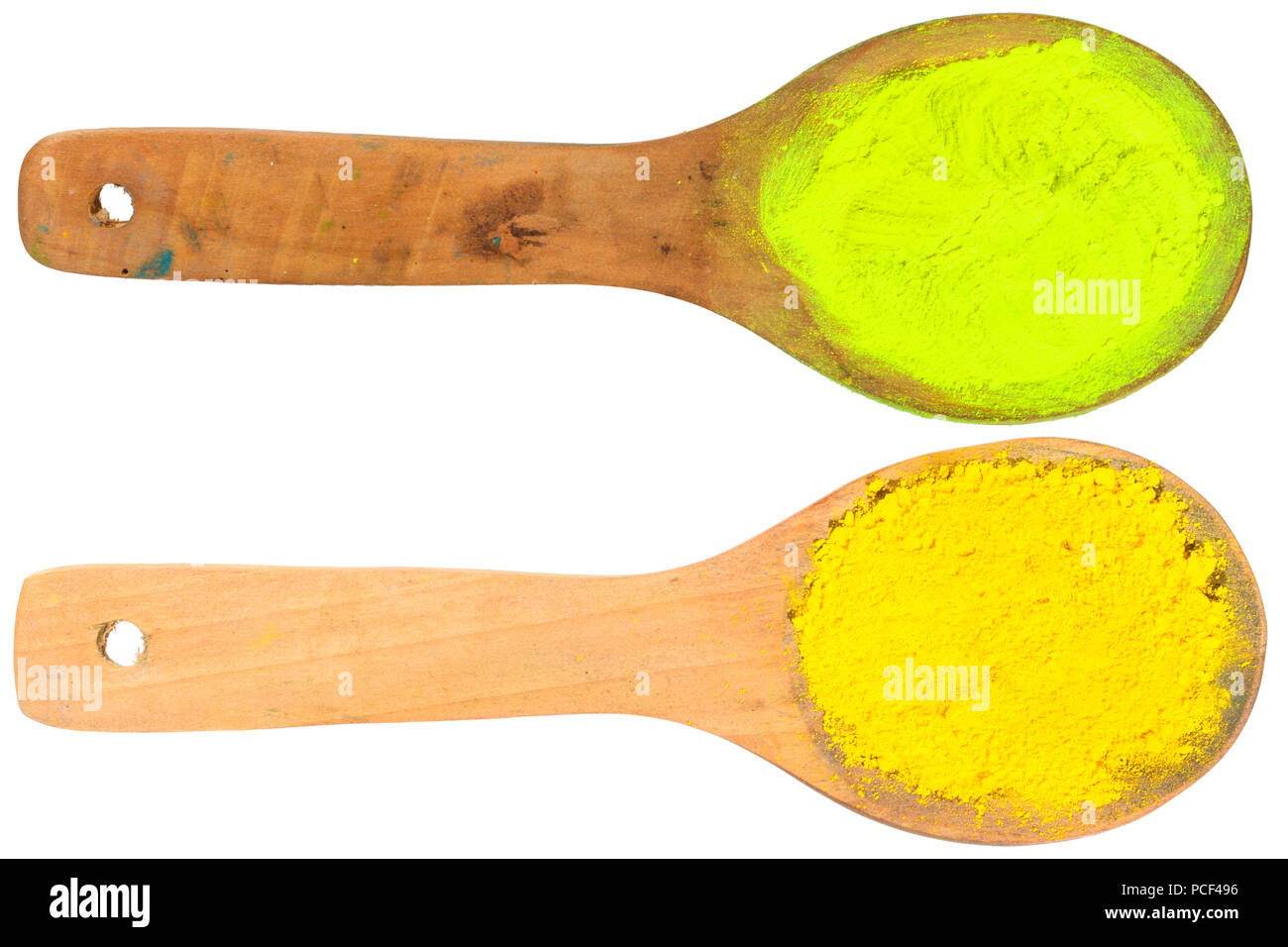 yellow and light yellow powder on wooden spoons with clipping path in ...