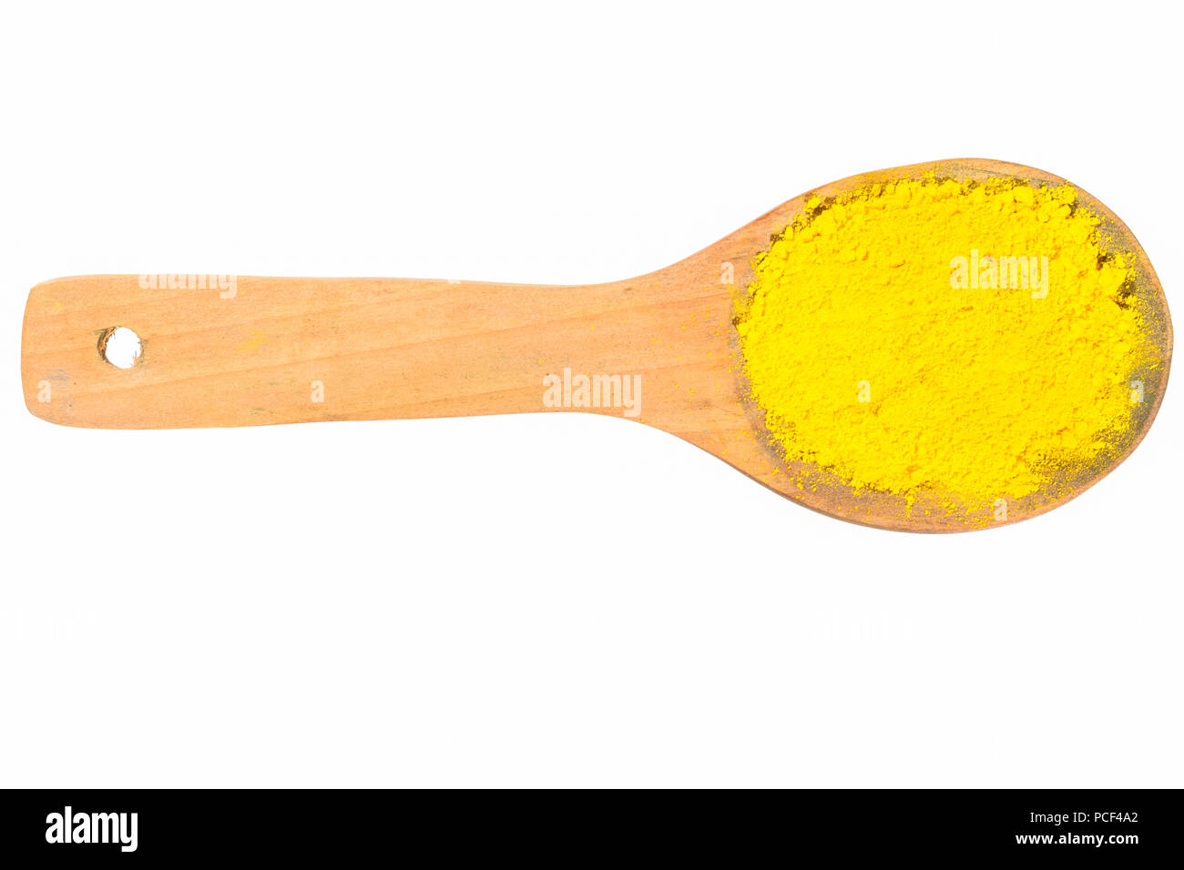 yellow powder on wooden spoon with clipping path in isolated on white ...