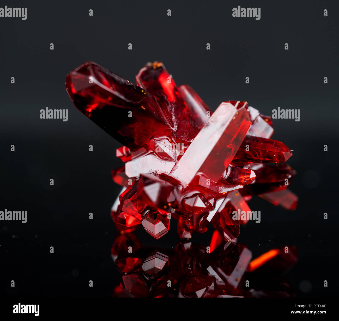 red crystal of natural origin. close up of crystals in ruby color on ...