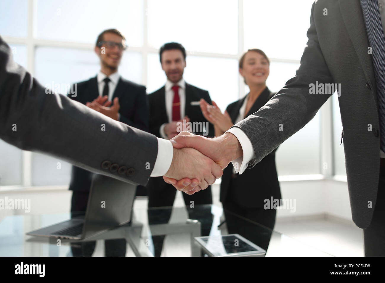 business handshake over blurry background office Stock Photo - Alamy