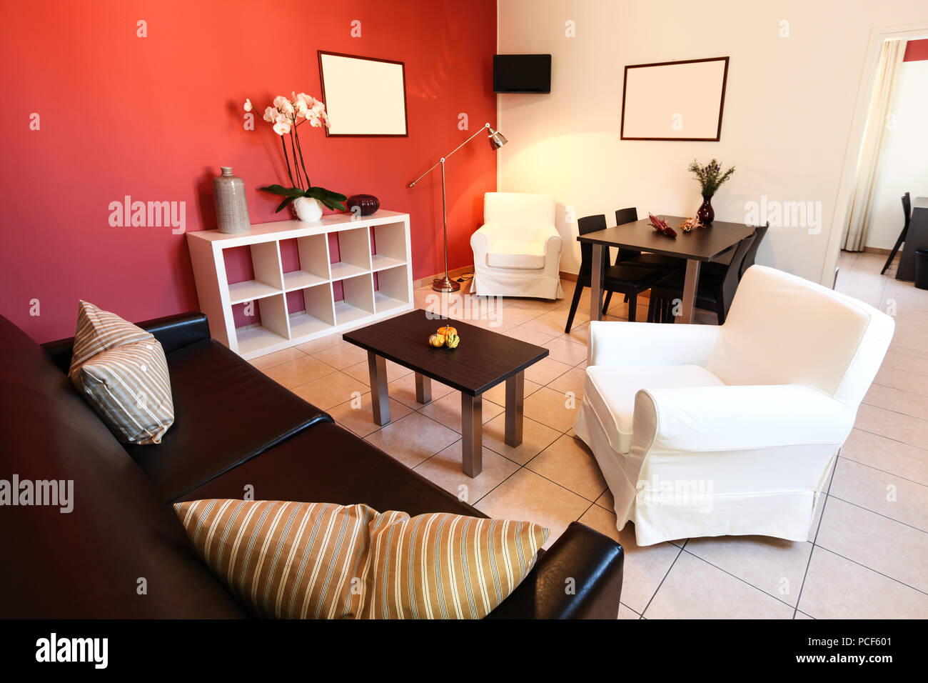 interior of apartment, living room with red wall Stock Photo - Alamy