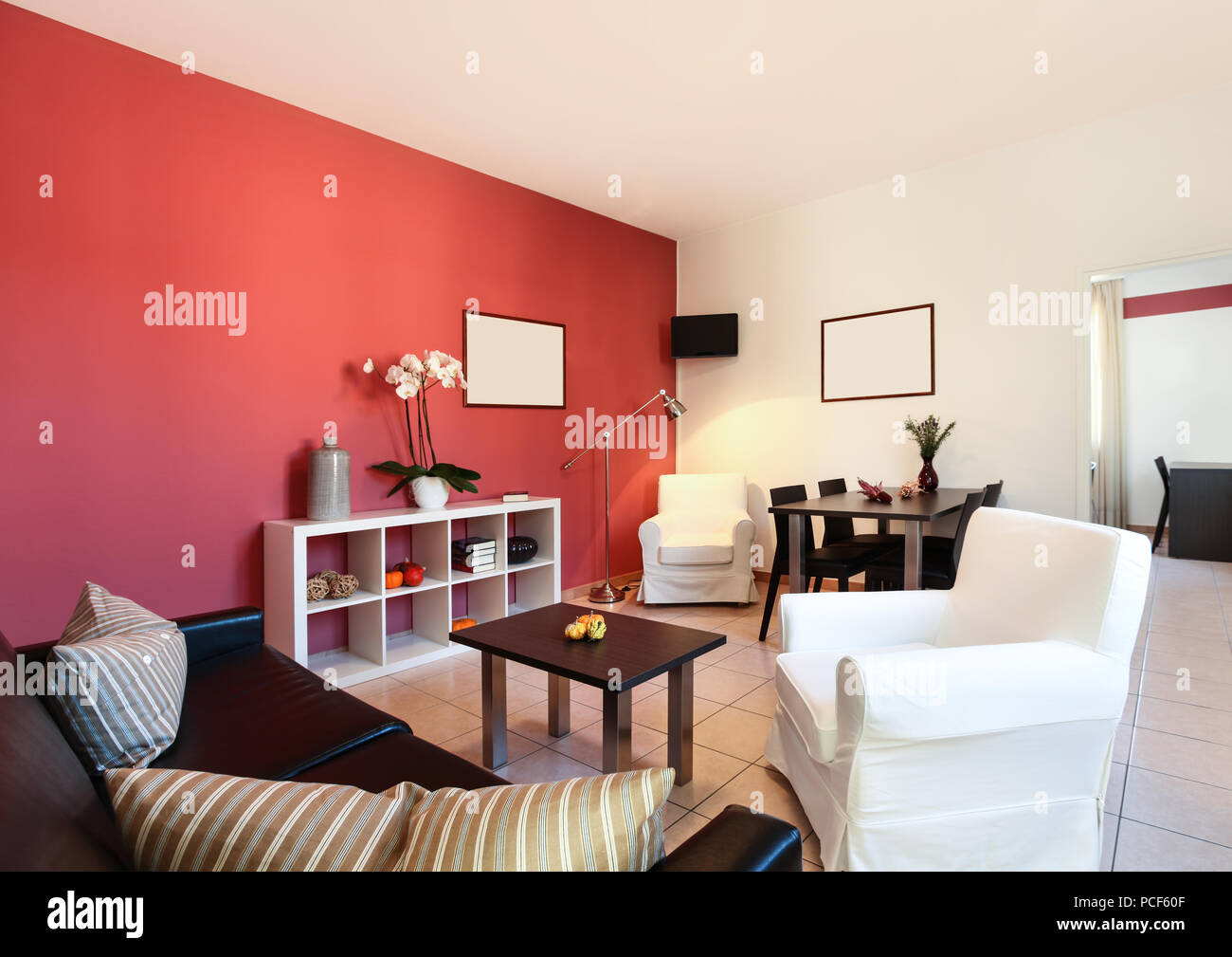 Interior of apartment, living room with red wall Stock Photo - Alamy