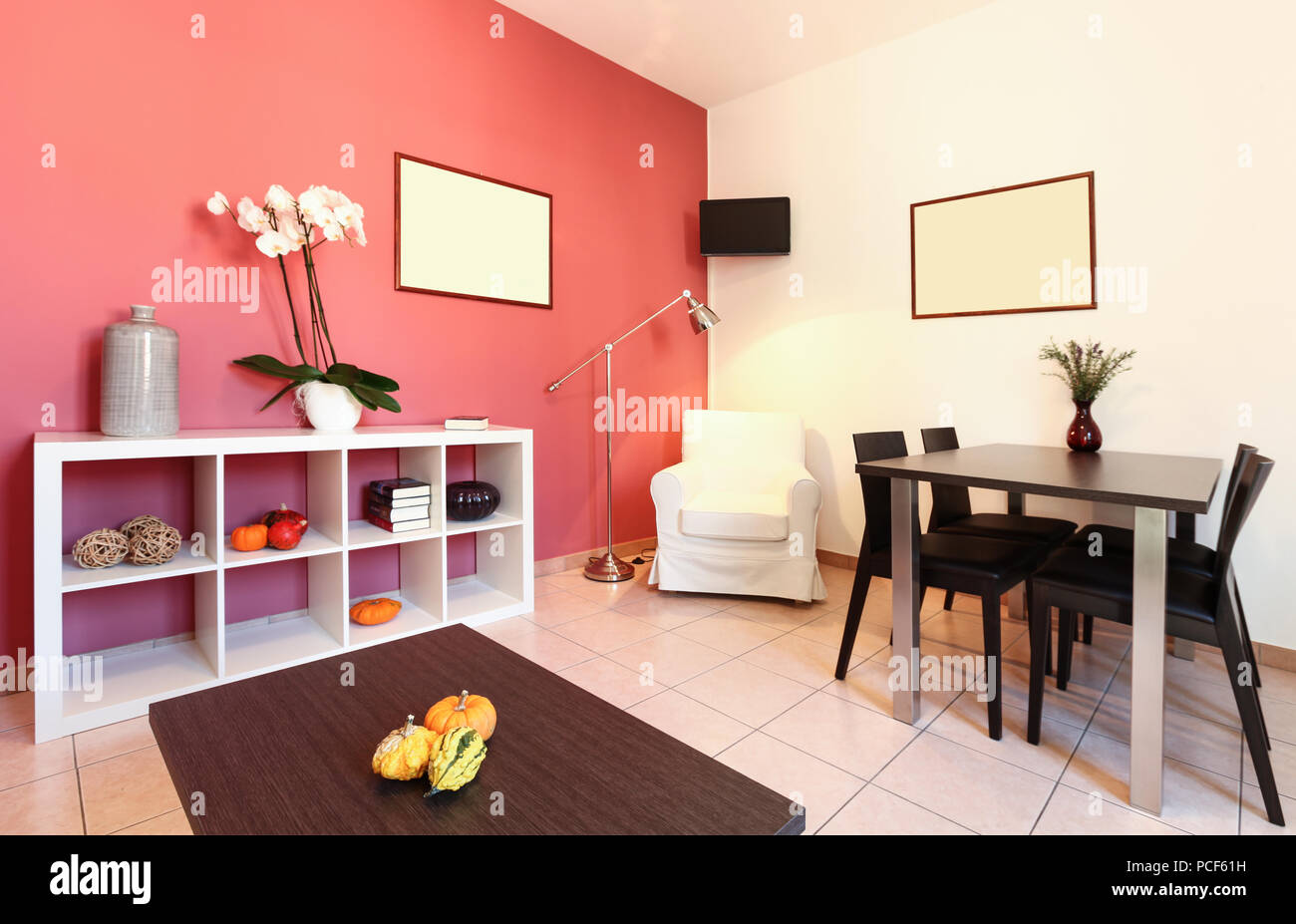 interior of apartment, living room with red wall Stock Photo - Alamy