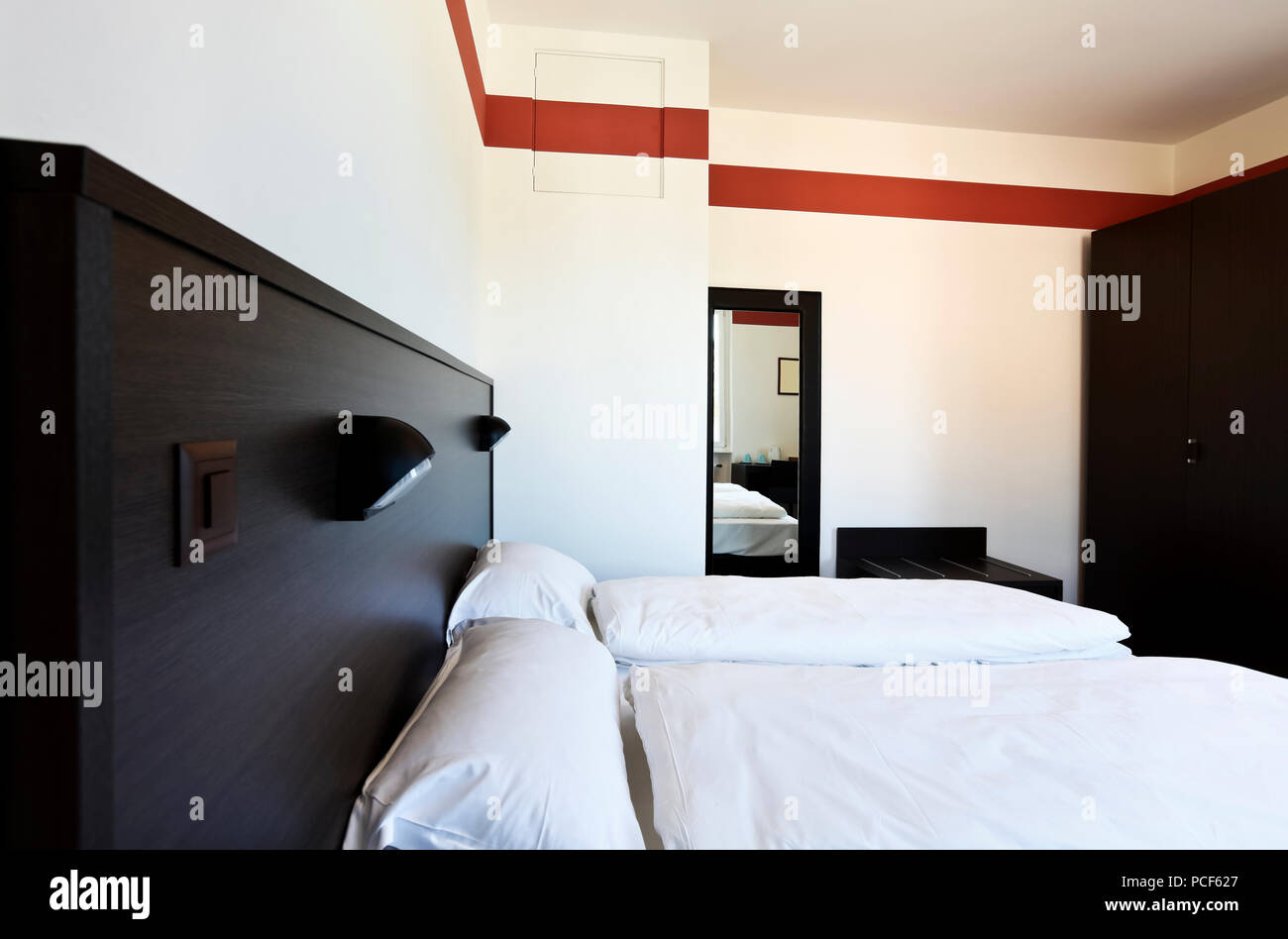 simple hotel room, double bed Stock Photo - Alamy