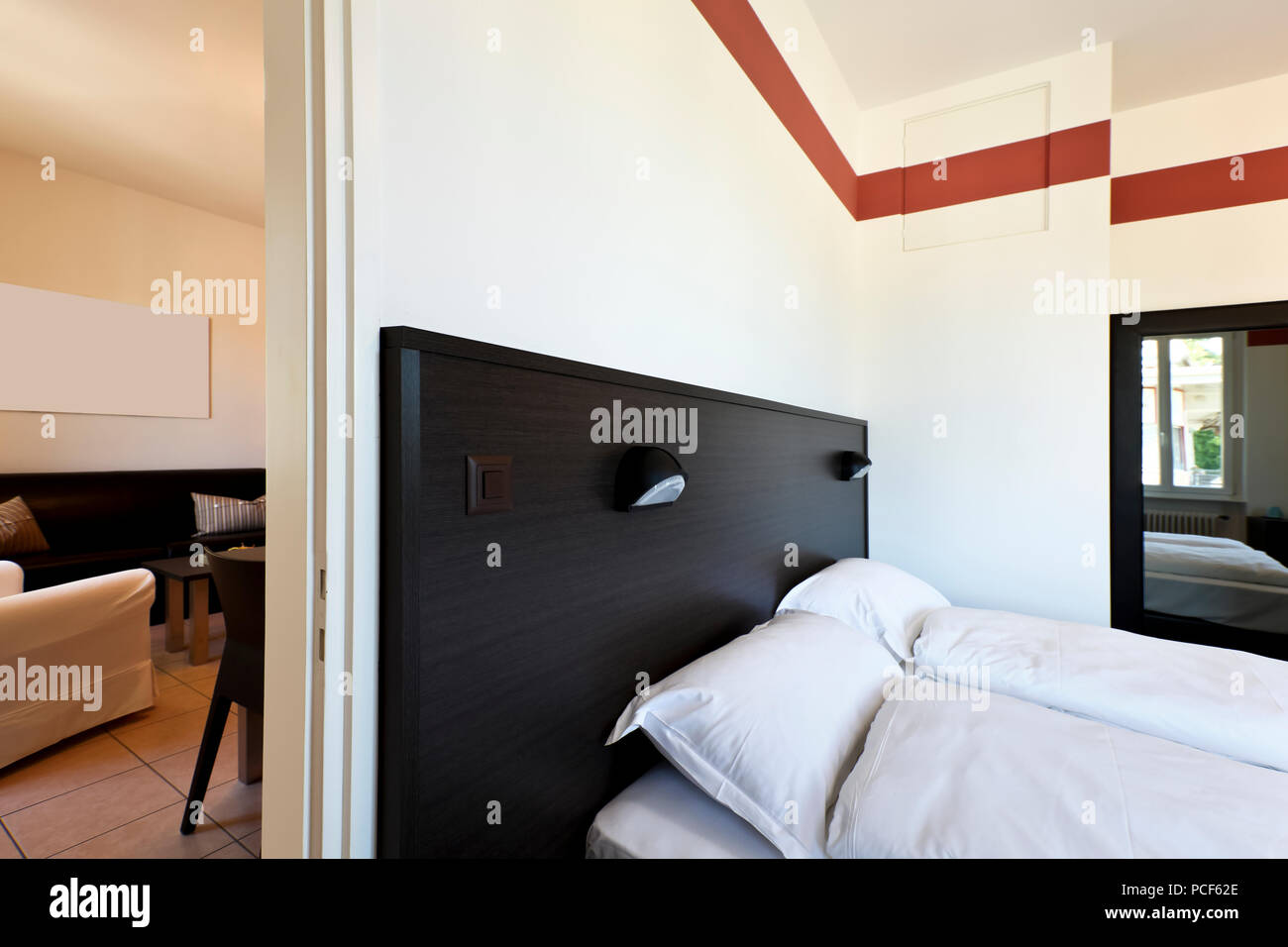 simple hotel room, double bed Stock Photo - Alamy