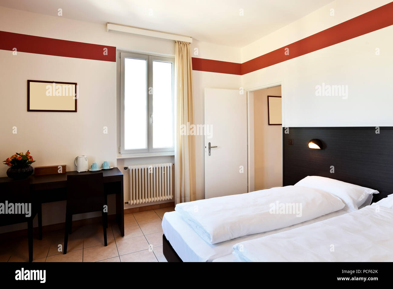 simple hotel room, double bed Stock Photo - Alamy